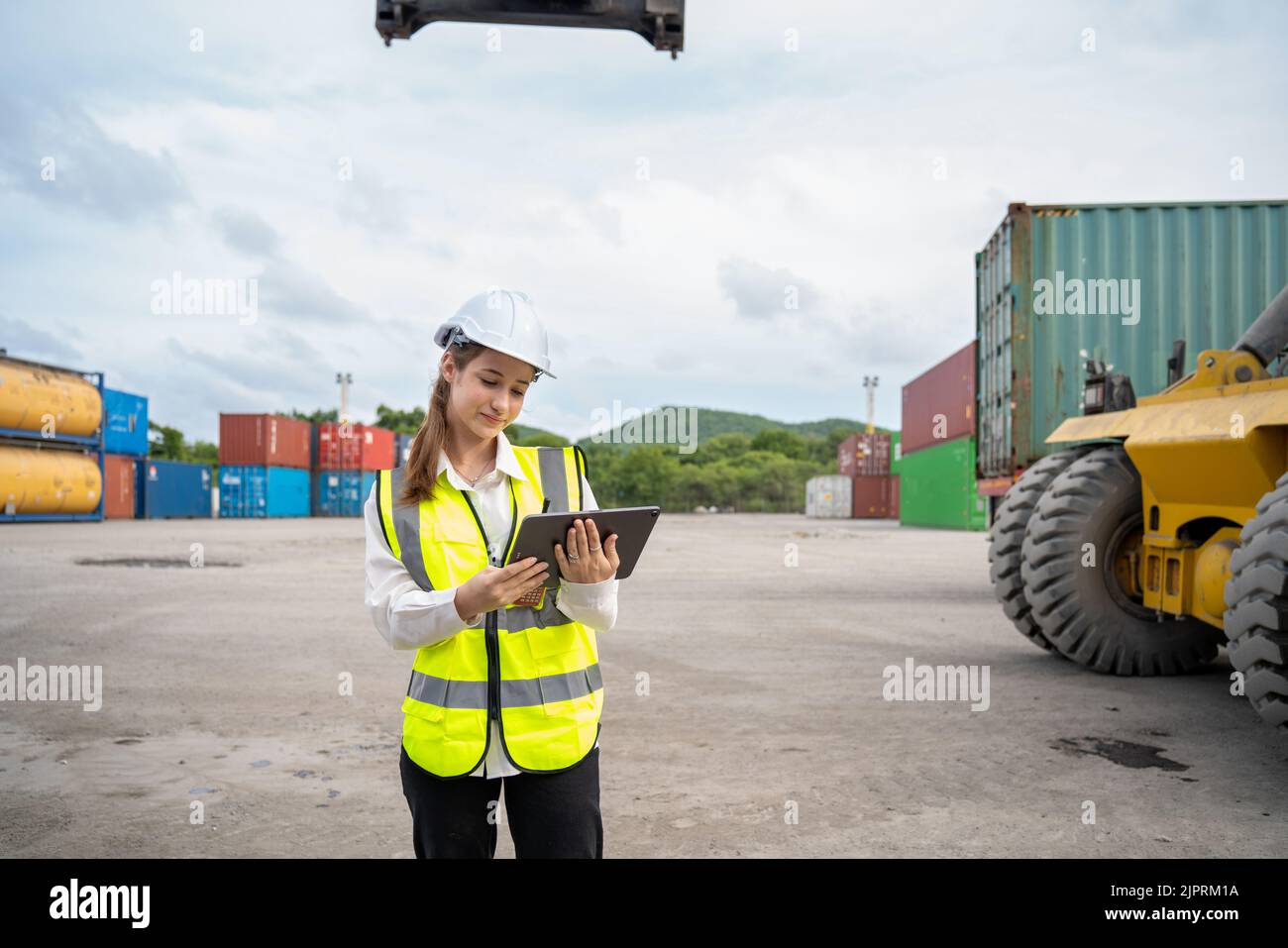 Woman foreman control forklift loading Containers cargo from Truck to ...
