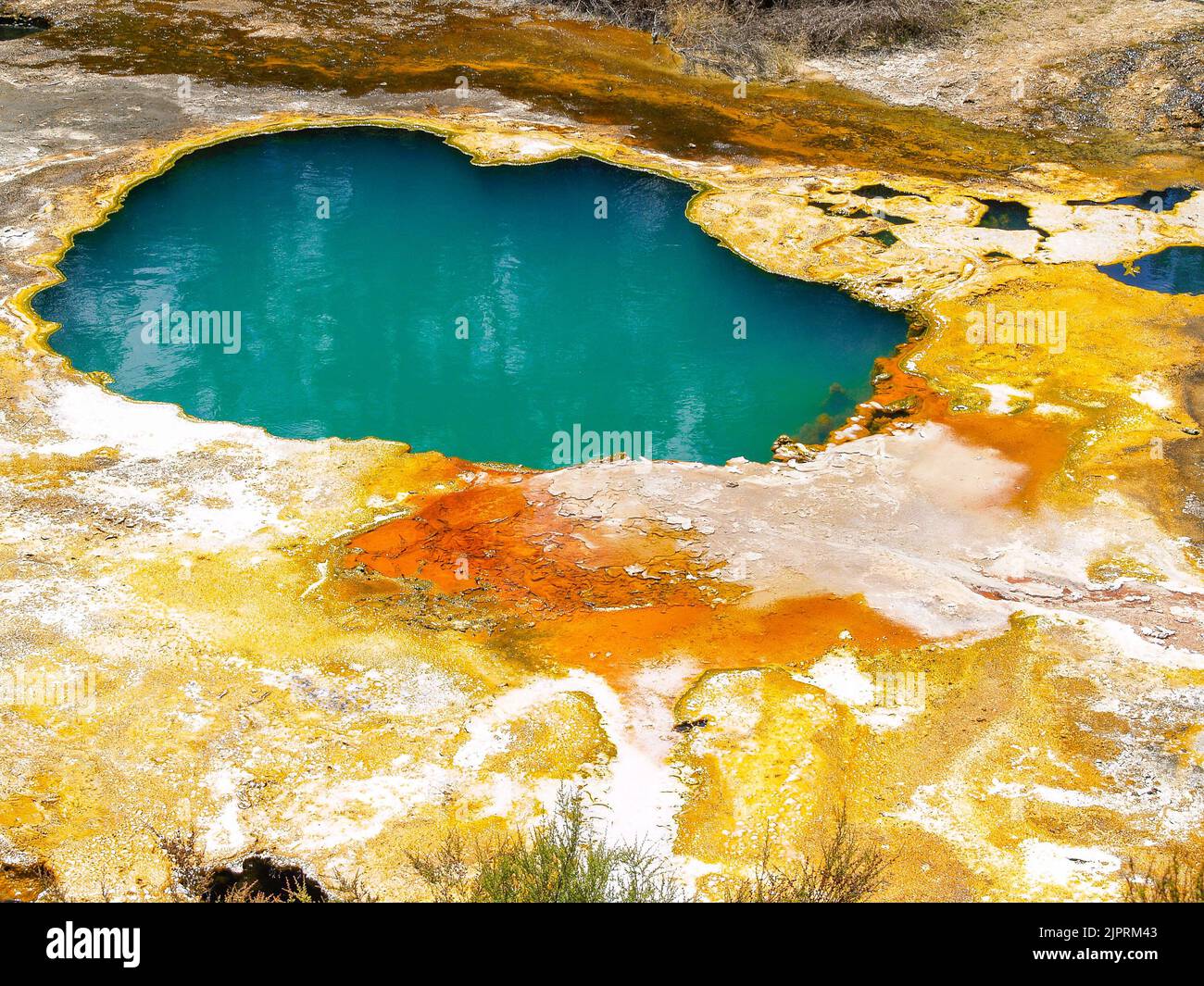 Bright sulfuric coloured land in yellow and brown surrounding turquoise ...