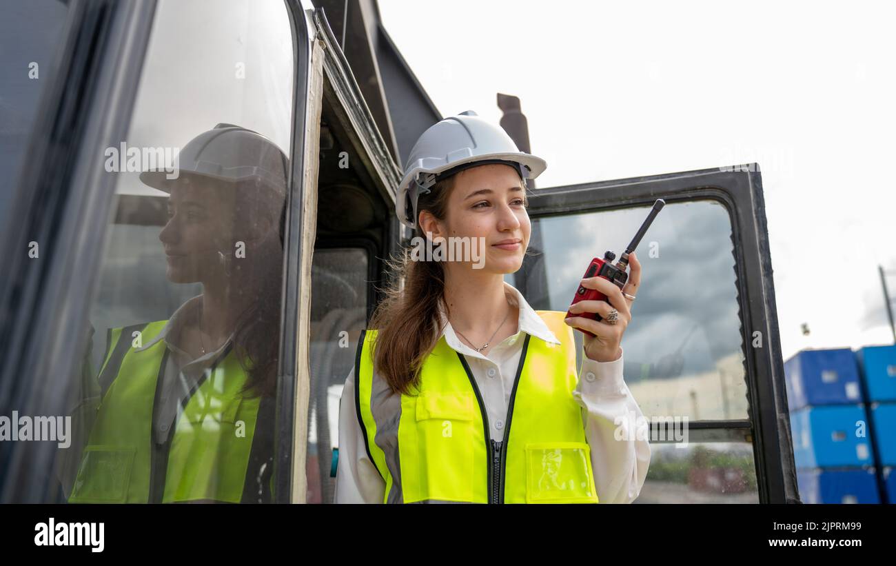 Female Foreman stay on lifting forklift container cargo forklift using ...