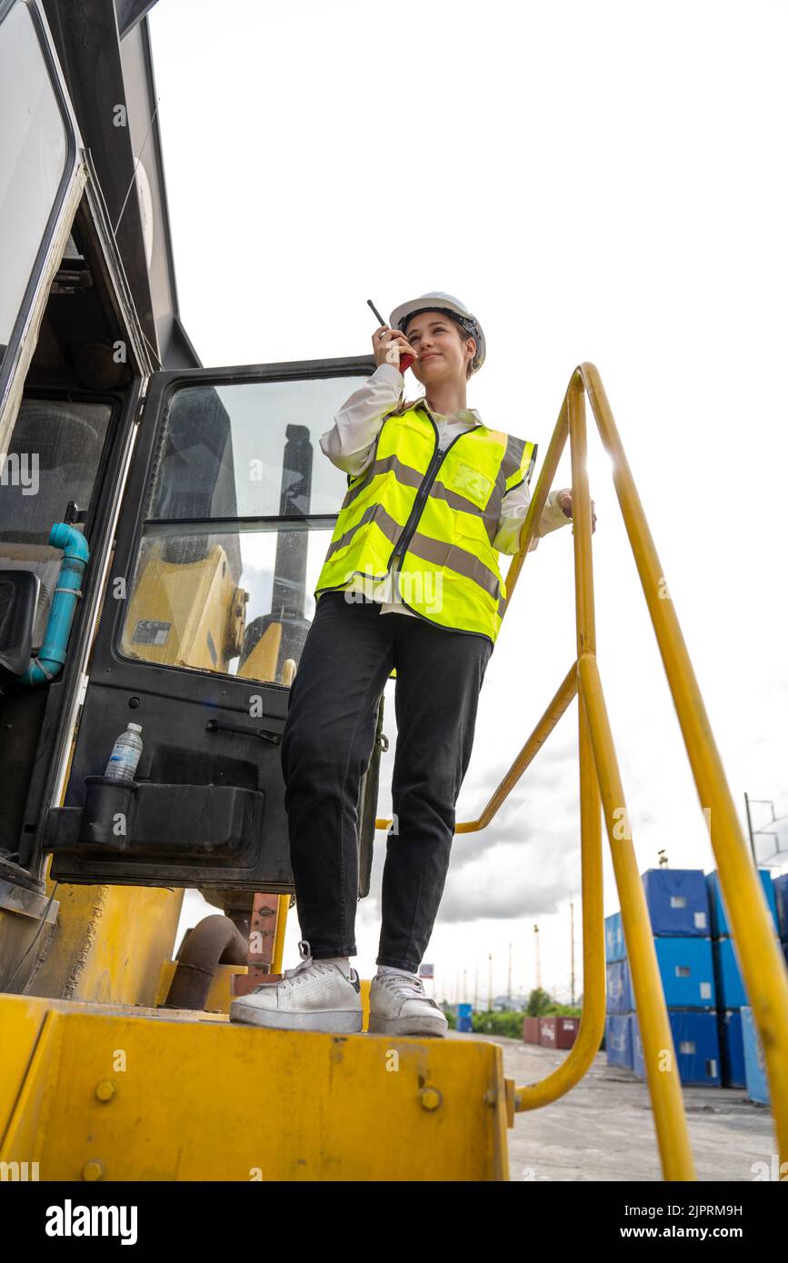 Female Foreman stay on lifting forklift container cargo forklift using ...