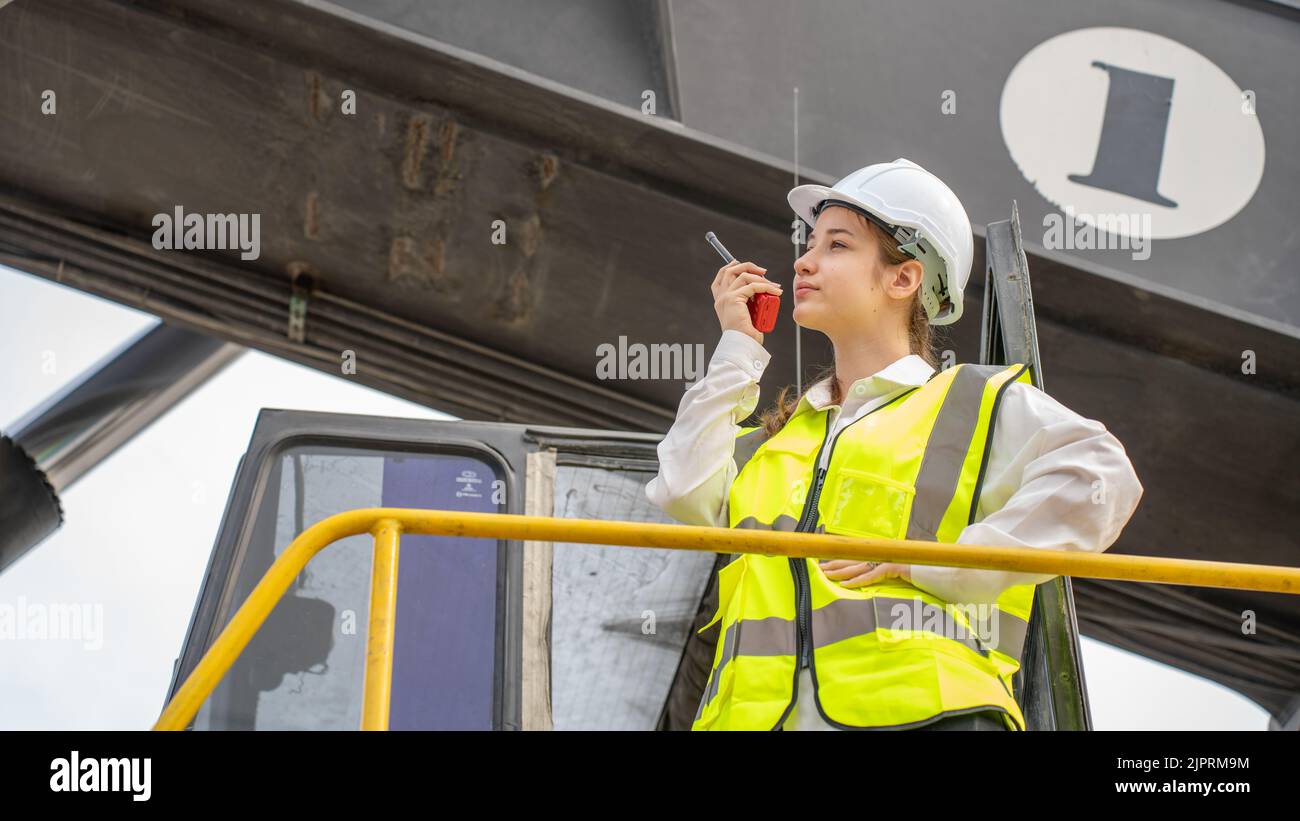 Female Foreman stay on lifting forklift container cargo forklift using ...