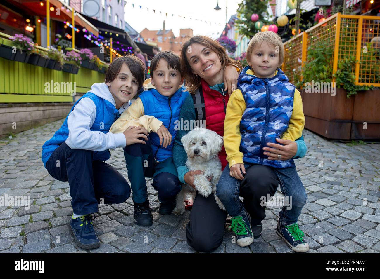 Happy family, children and adults, enjoying the colorful city of ...