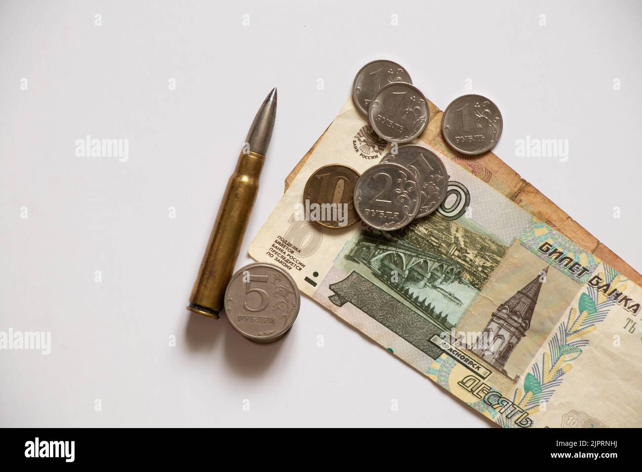 Russian rubles and a bullet on a white background. Financial sanctions ...