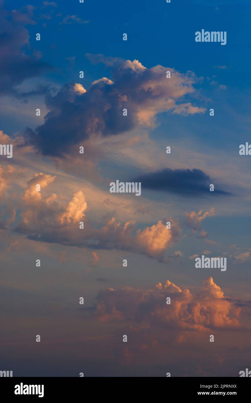 Clouds catch the setting suns sunlight Stock Photo - Alamy