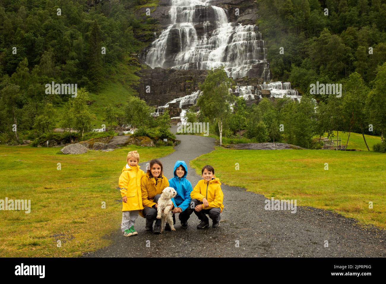 People, visiting Tvinnefossen waterfall, children enjoying the amazing ...