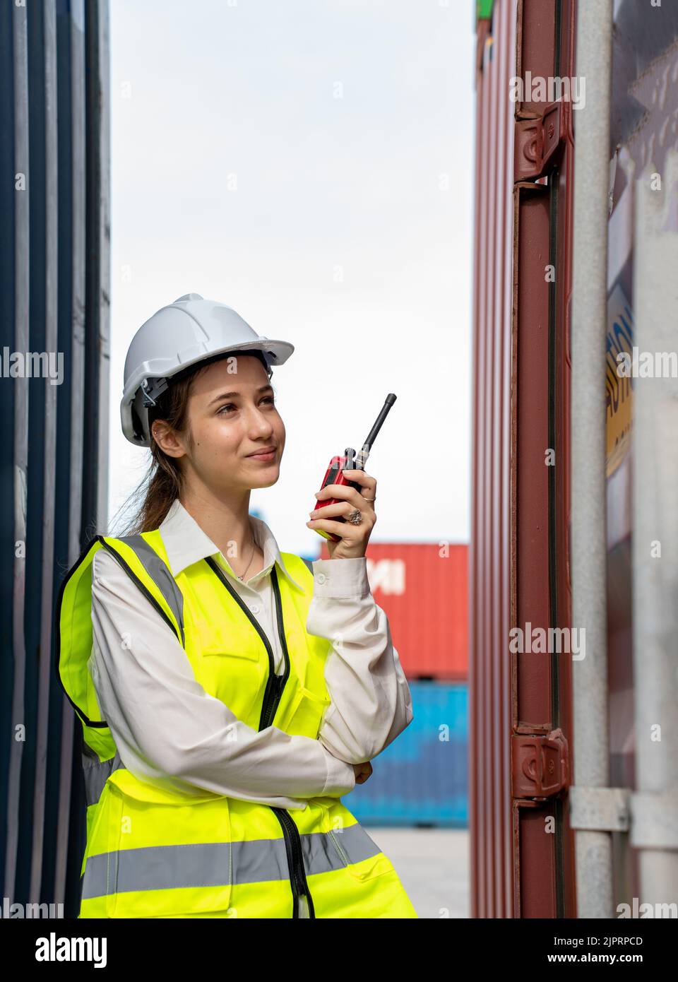 Woman foreman smile using walkie talkie in front of Cargo forklift in ...