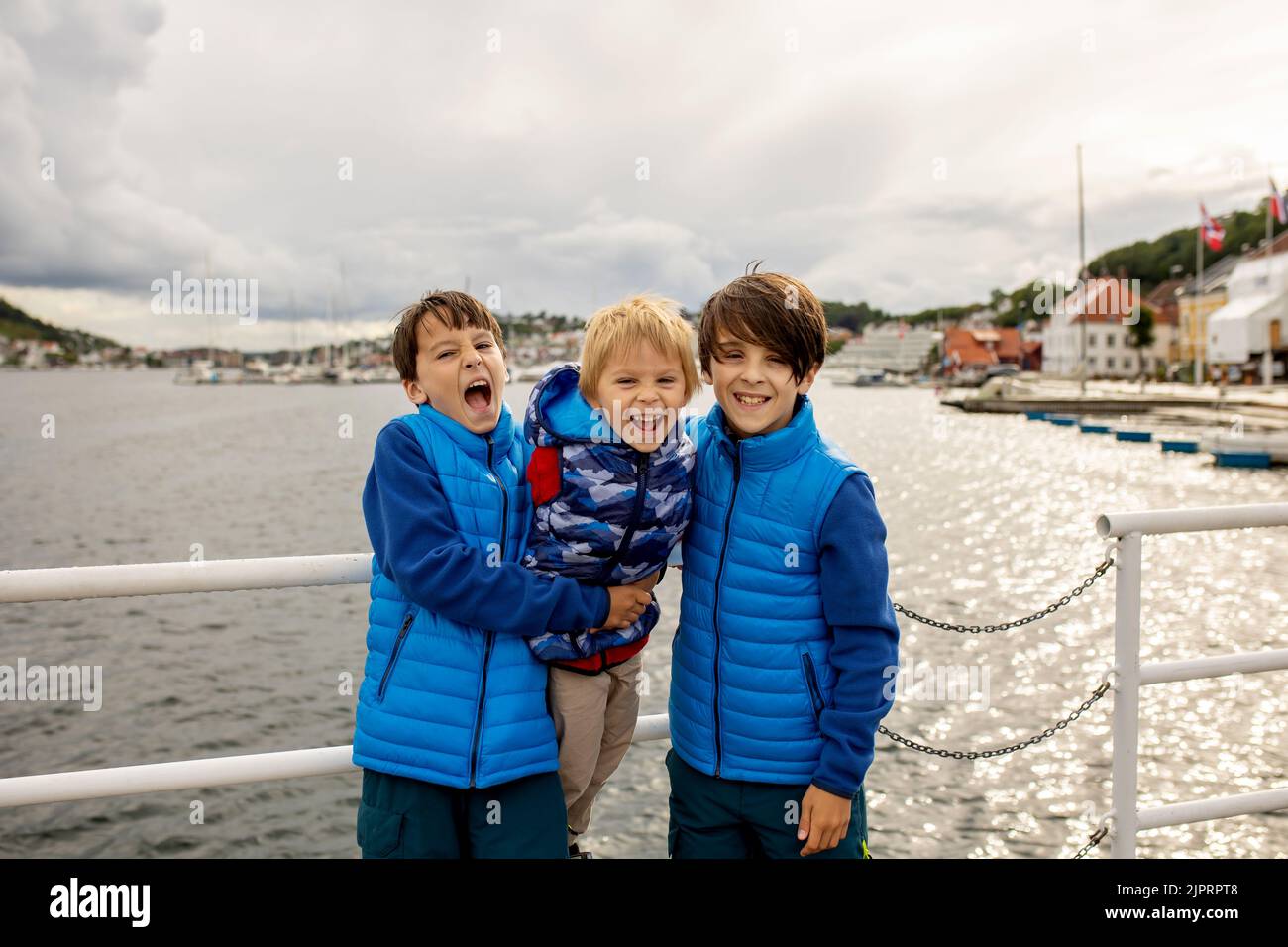 Child, visiting little town in south Norway, Arendal, on a rainy summer ...