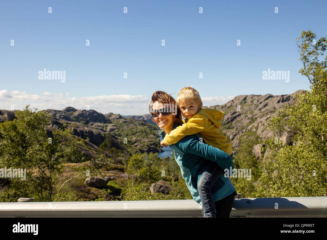 Happy people, enjoying amazing views in South Norway coastline, fjords ...