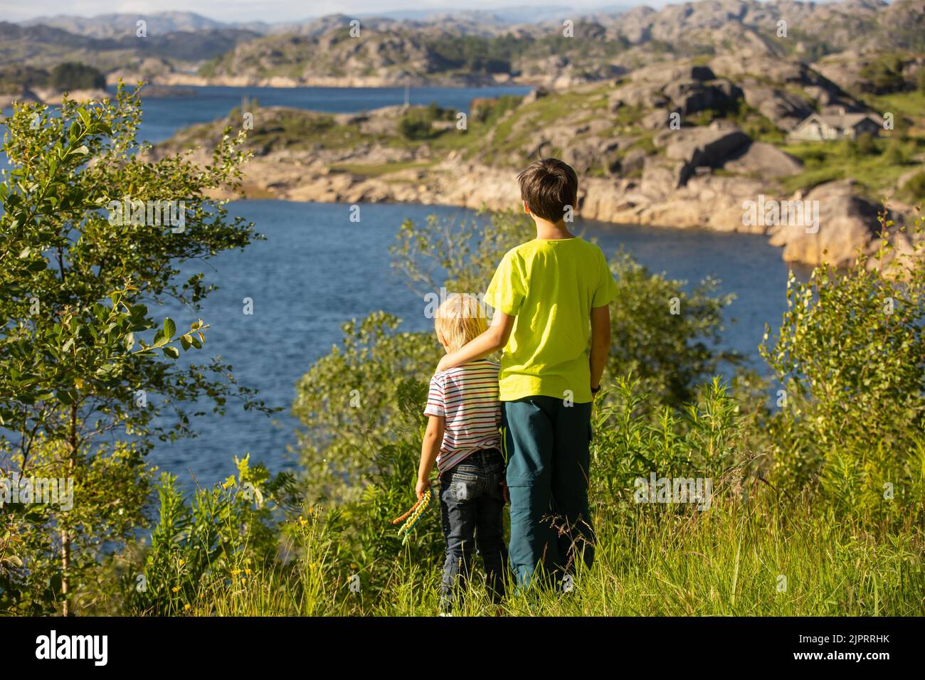 Happy people, enjoying amazing views in South Norway coastline, fjords ...