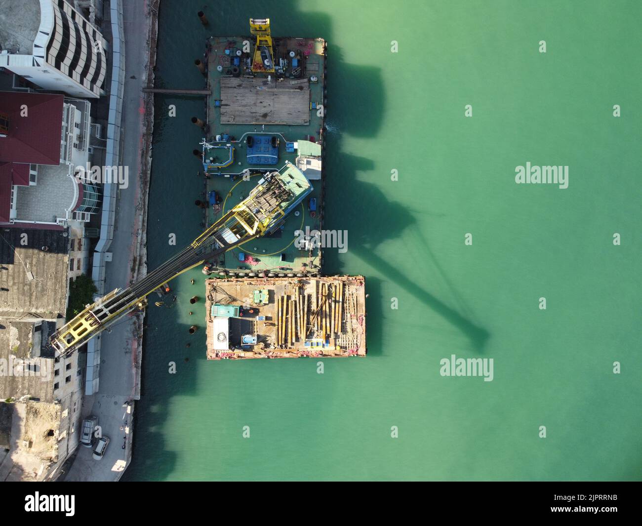 Floating crane dredging barges working on the construction of a marina. Aerial top view Stock ...