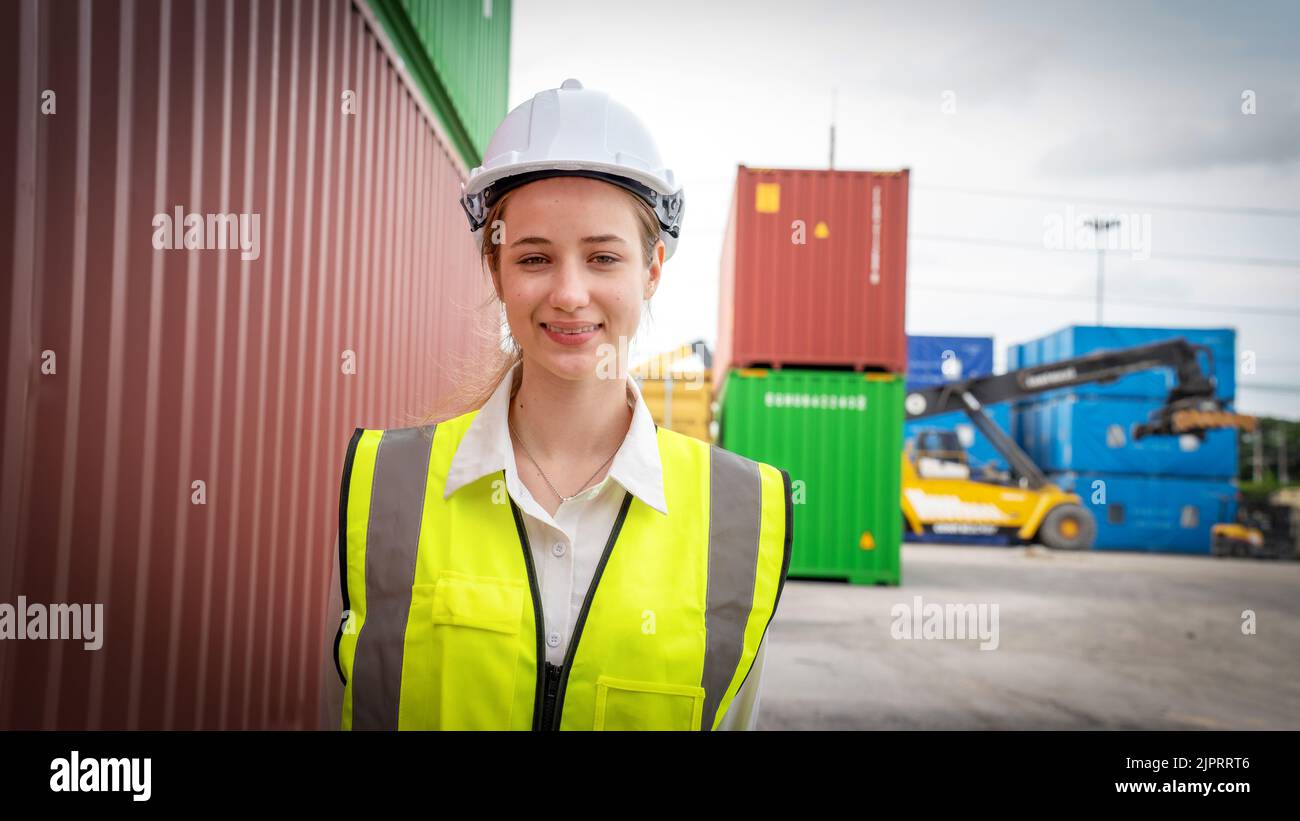 Woman foreman smile at side of Cargo container in warehouse , Manager ...