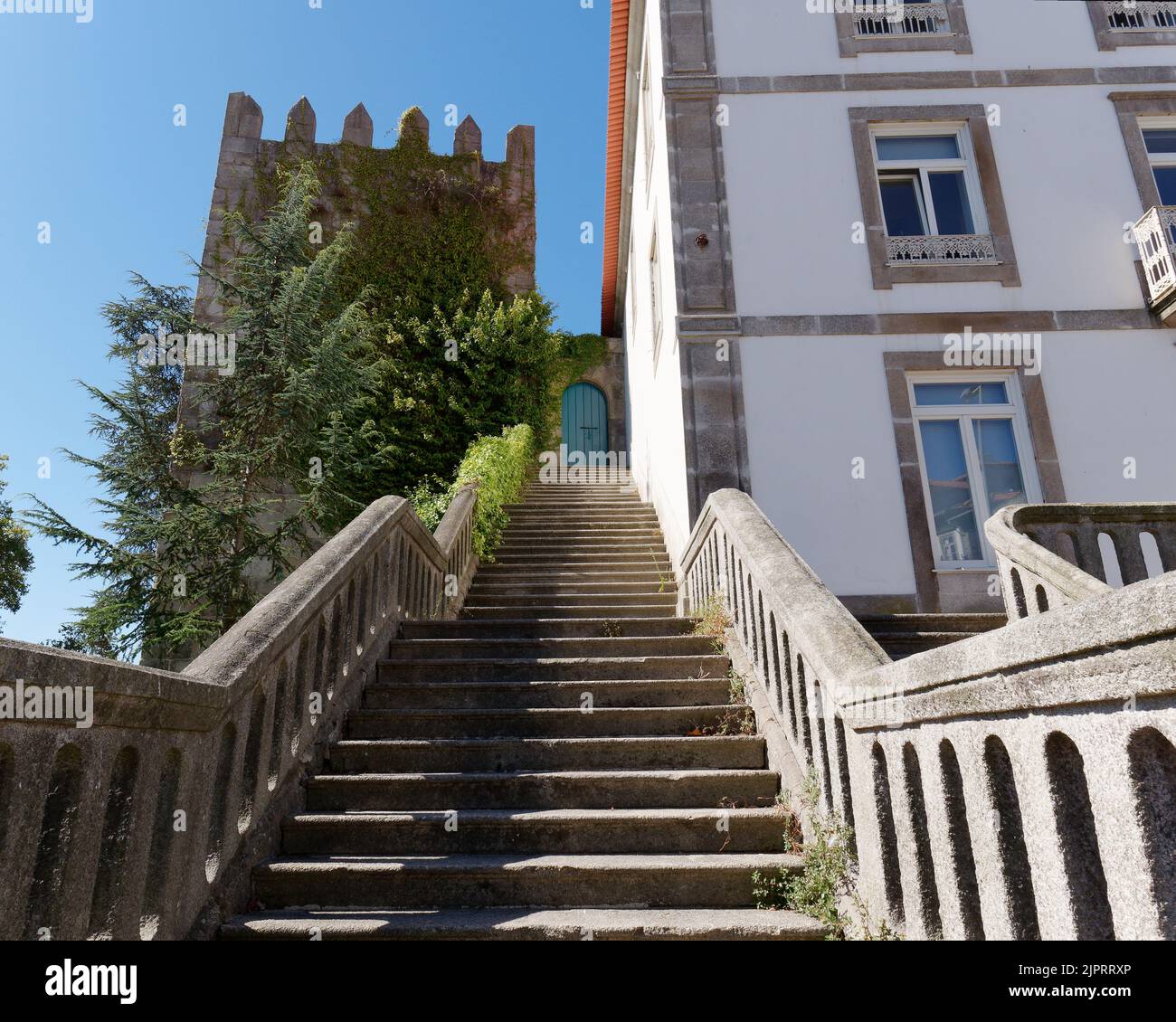Building with a white facade and steps leading to a turret attached to ...