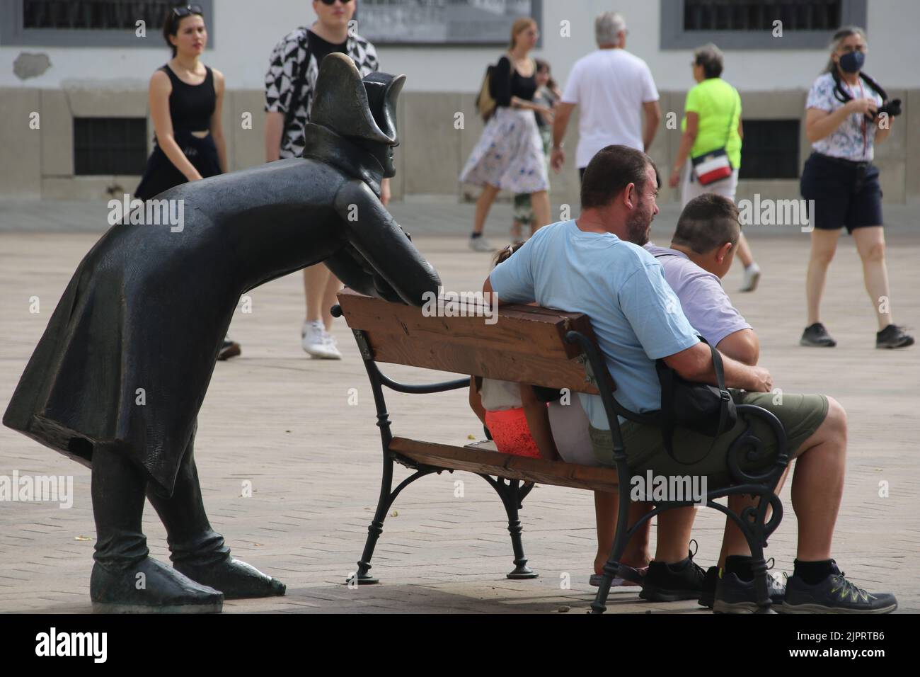 artwork statue watching over tourists Stock Photo - Alamy