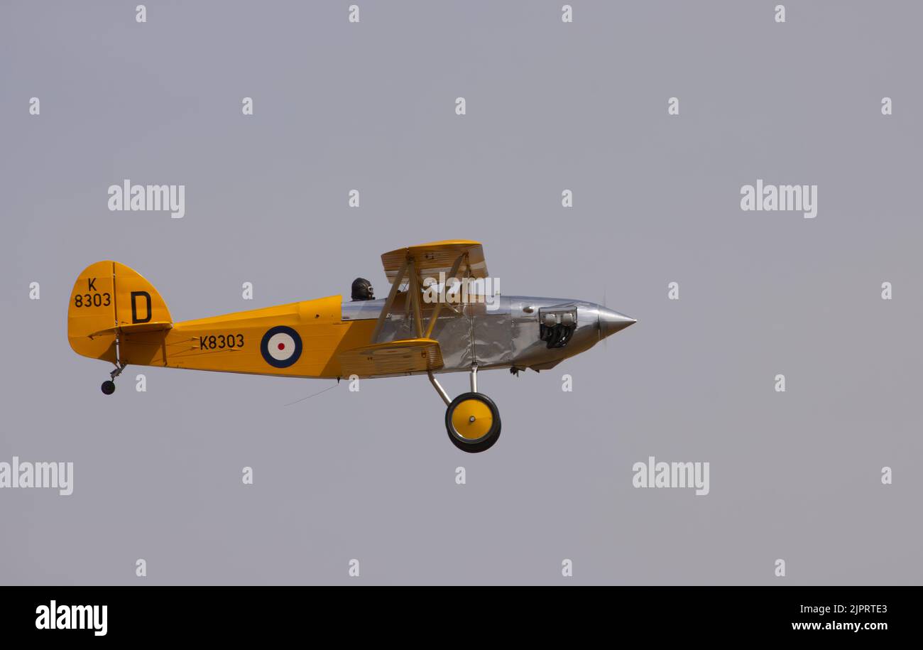 A yellow Isaacs Fury (replica 1935 Hawker Fury) aeroplane in flight ...