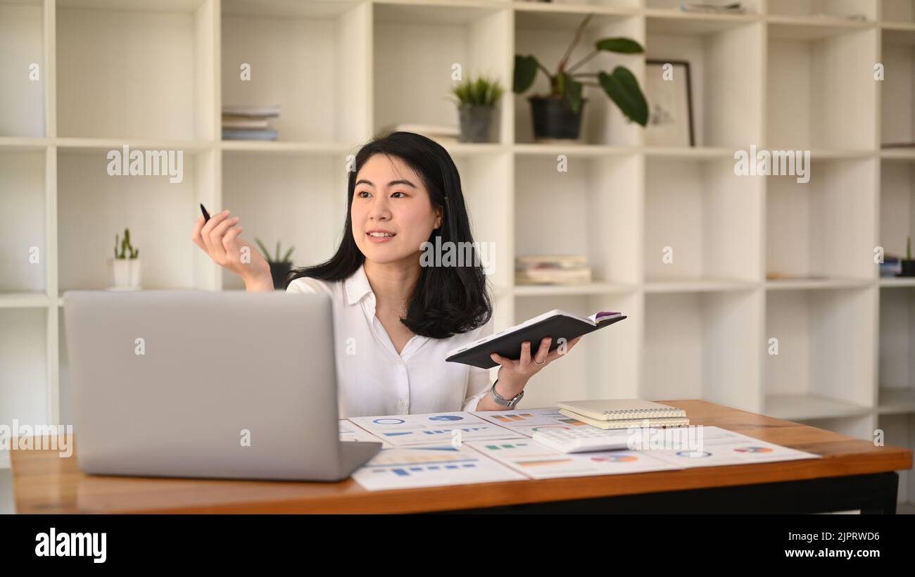 Millennial business lady using laptop and checking financial data at ...