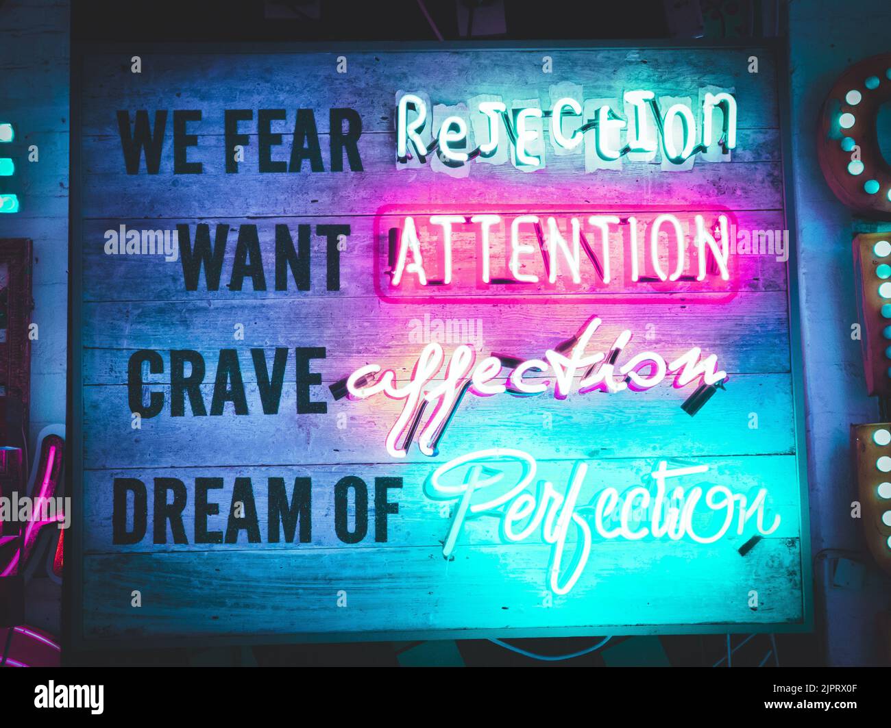 A motivation illuminated neon sign quote on a wall Stock Photo - Alamy
