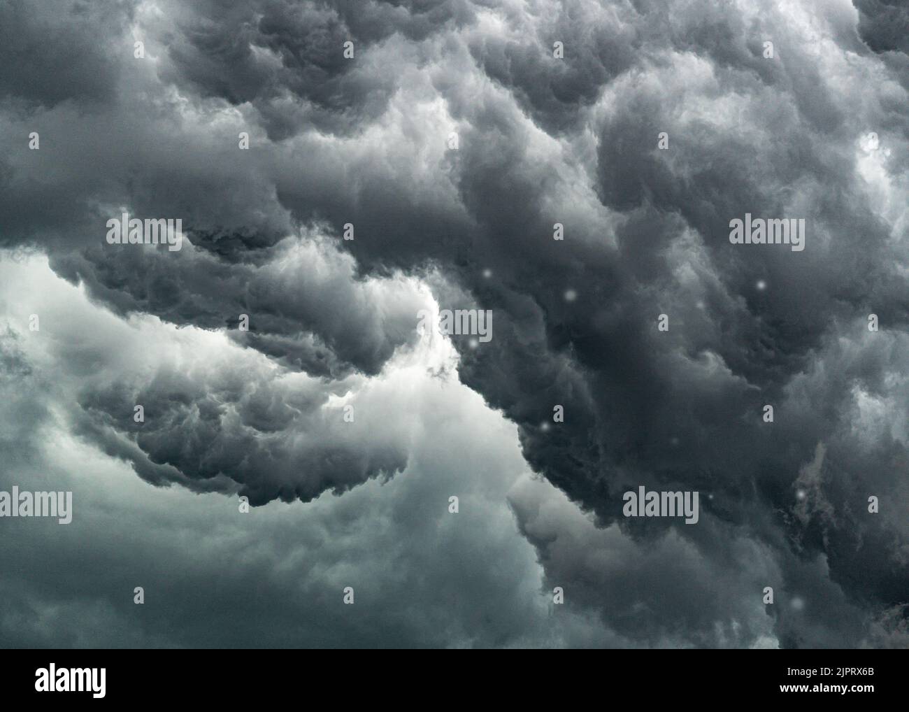 Storm clouds in the shape of faces with eyes that look at the earth ...