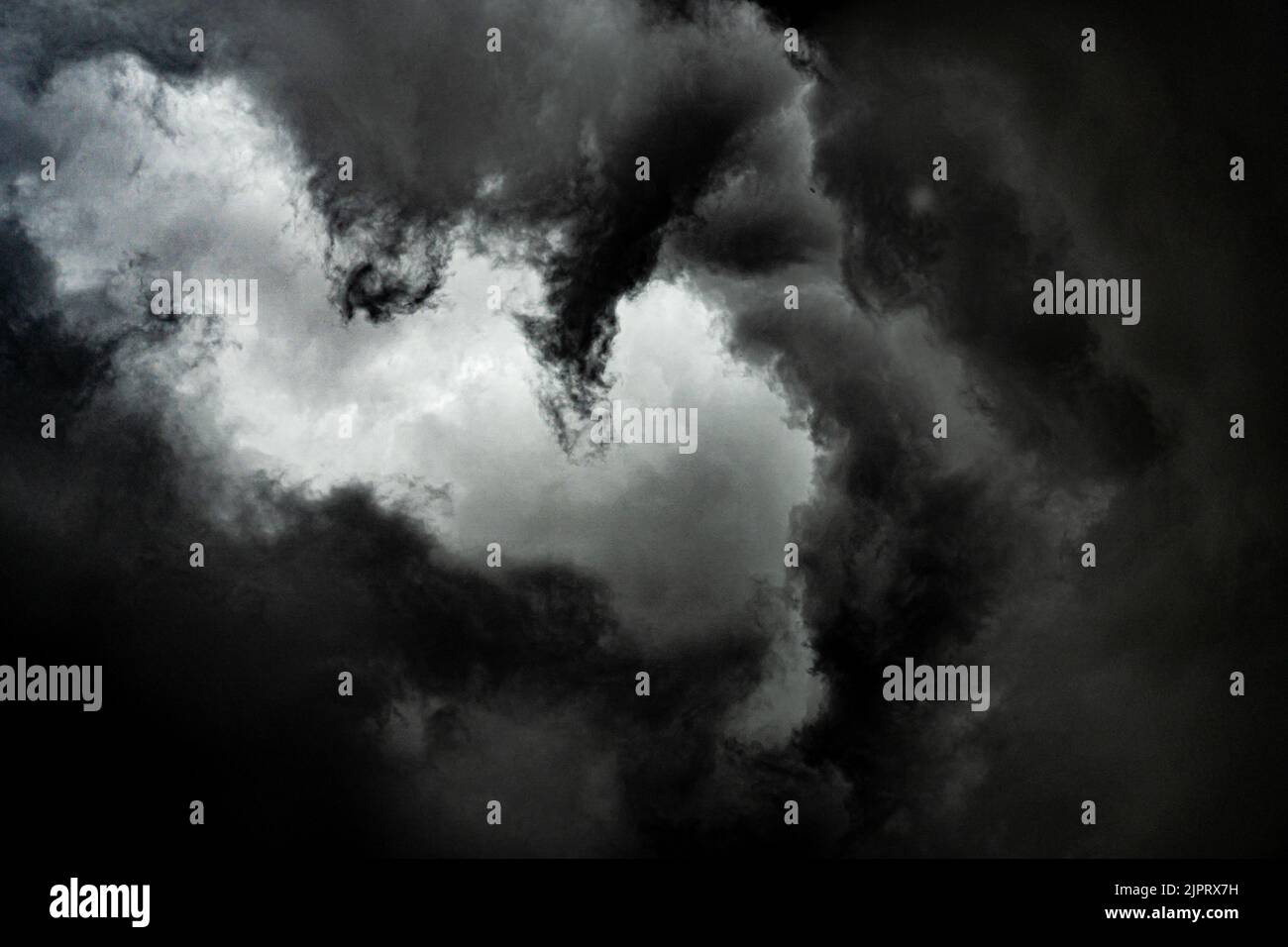 Dark god face in storm cloud formation with eye of hurricane in the ...