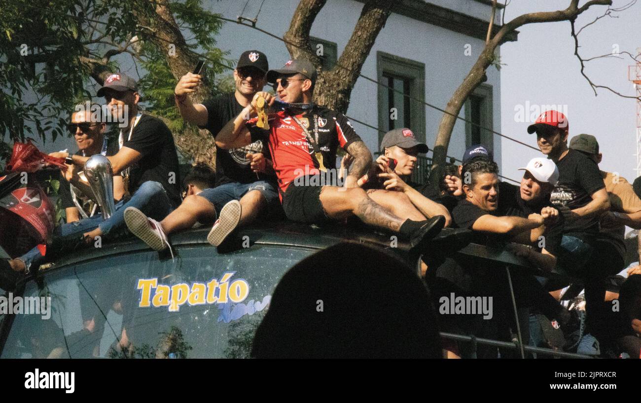 The group of young football club fans sitting on top of a bus at the ...