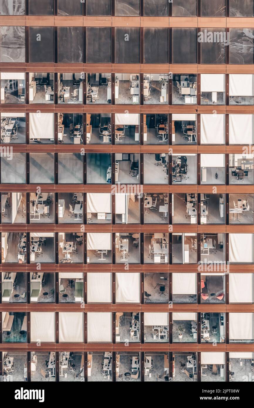 A vertical front view of a glass office building from windows Stock ...