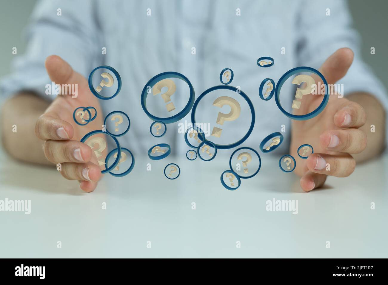 A man holding the floating 3D rendered question mark icons Stock Photo ...