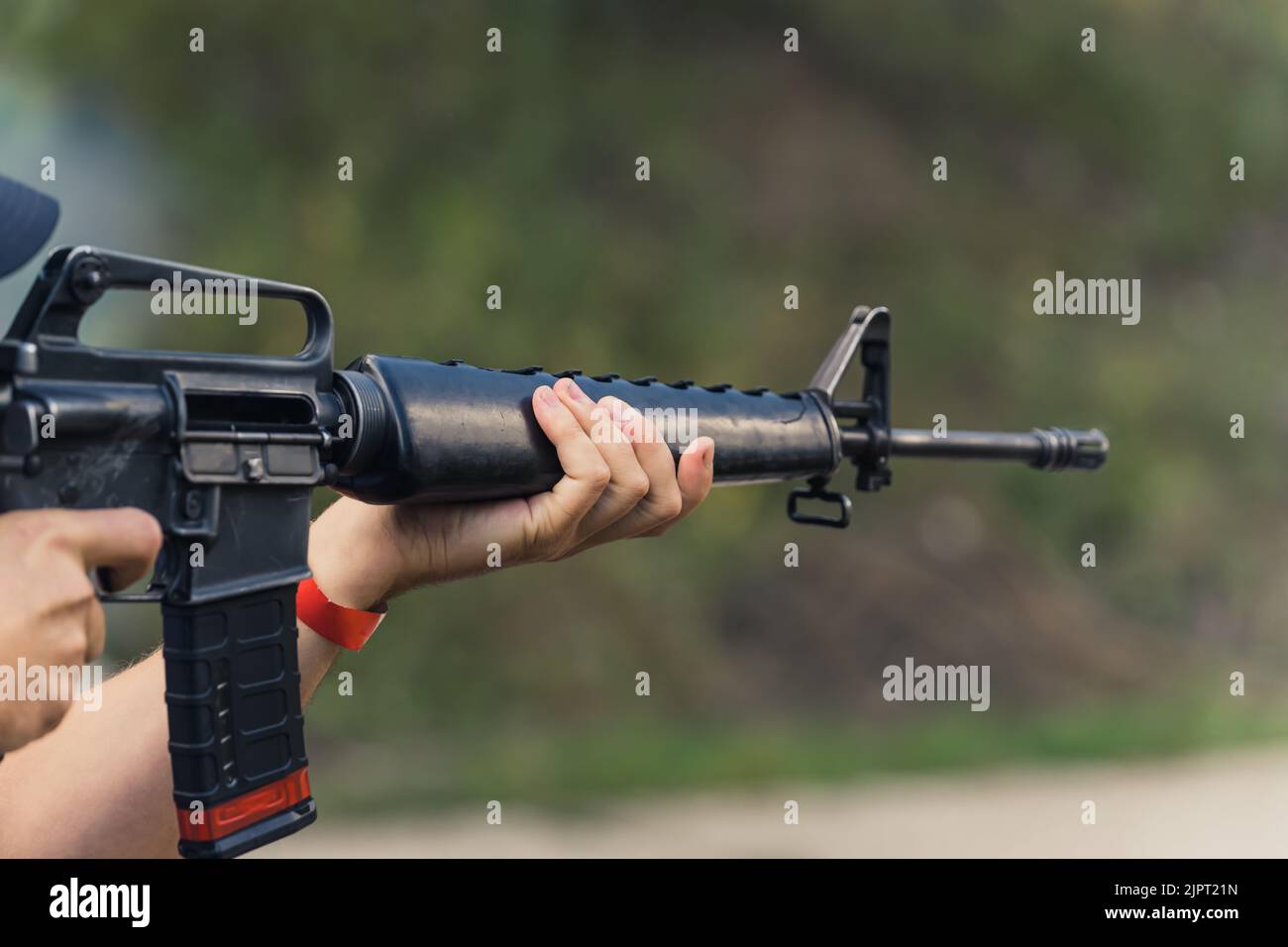 Hands aiming submachine gun. Firearms training. Target practice at ...