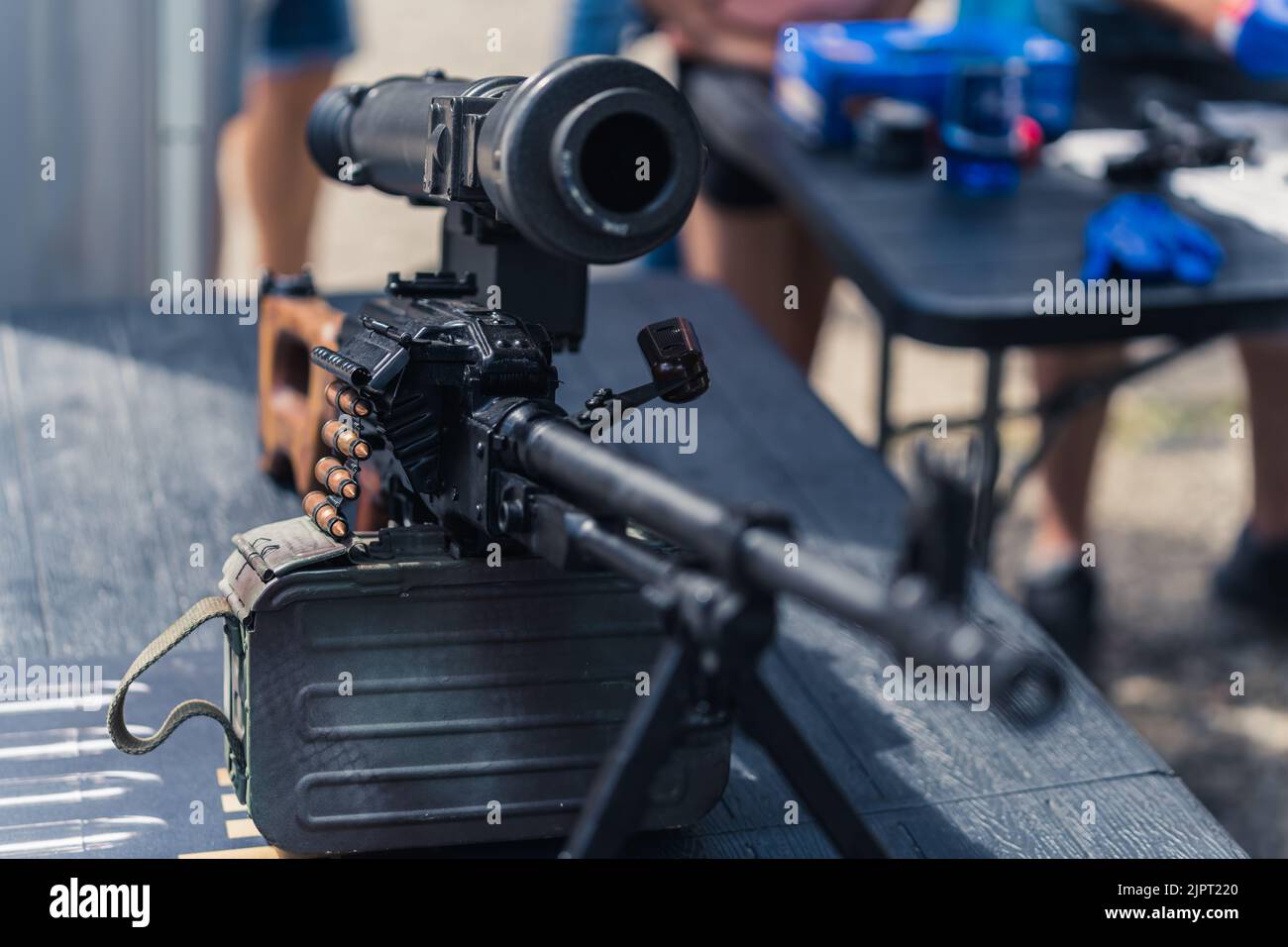 Close up front view of rifle gun scope and barrel standing on table at ...