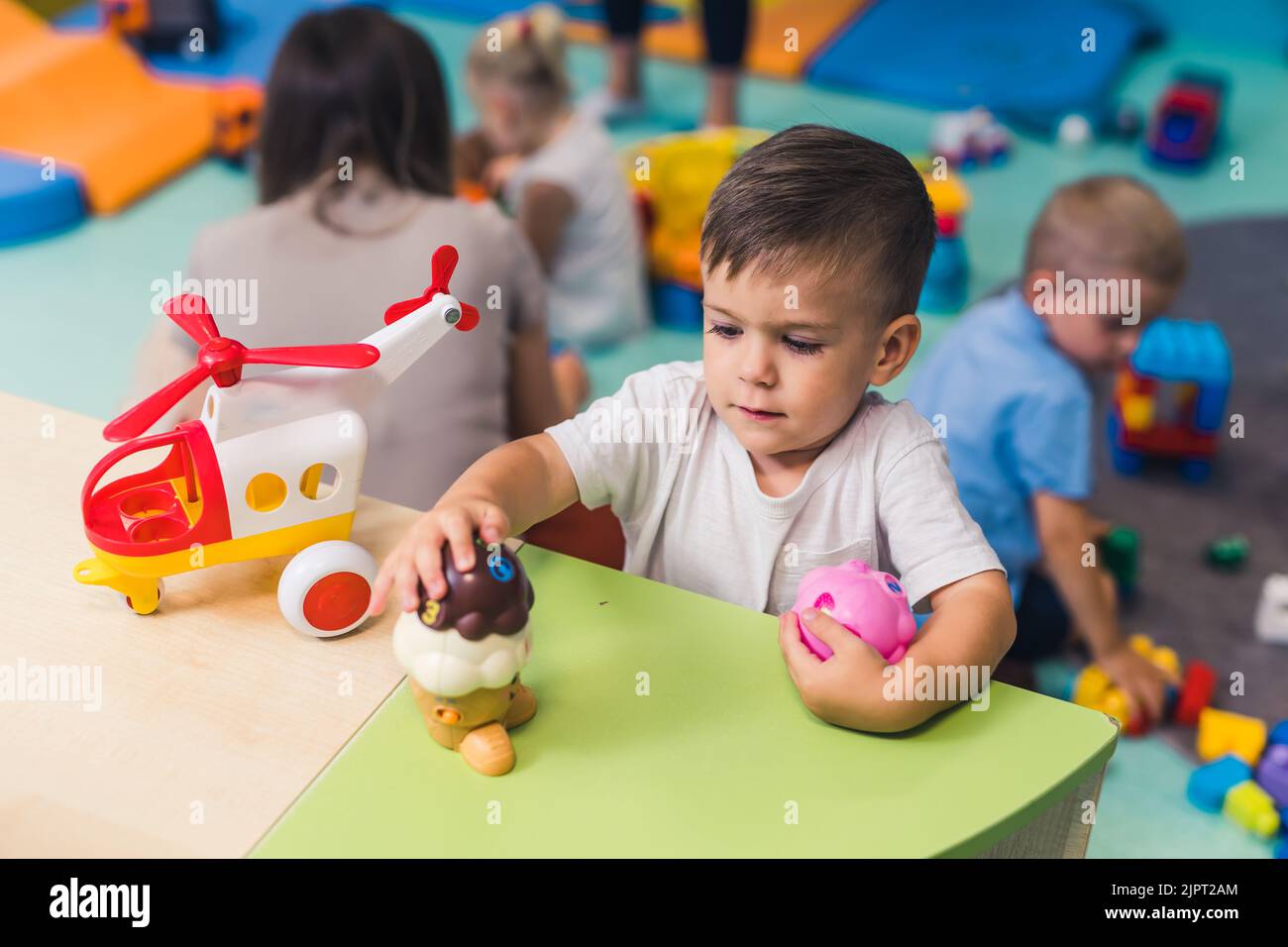 children playing with toys in the kindergarten. High quality photo ...
