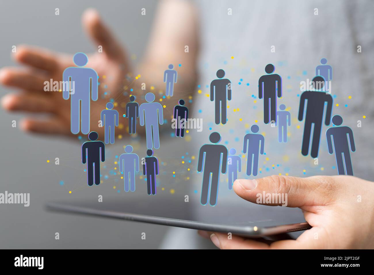 A group of 3D rendered people icons hovering over a man's hand holding ...