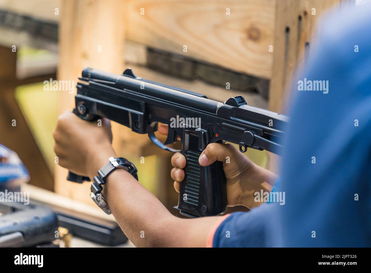Child holding polish PM Rak submachine gun. Target practice. Firearm ...