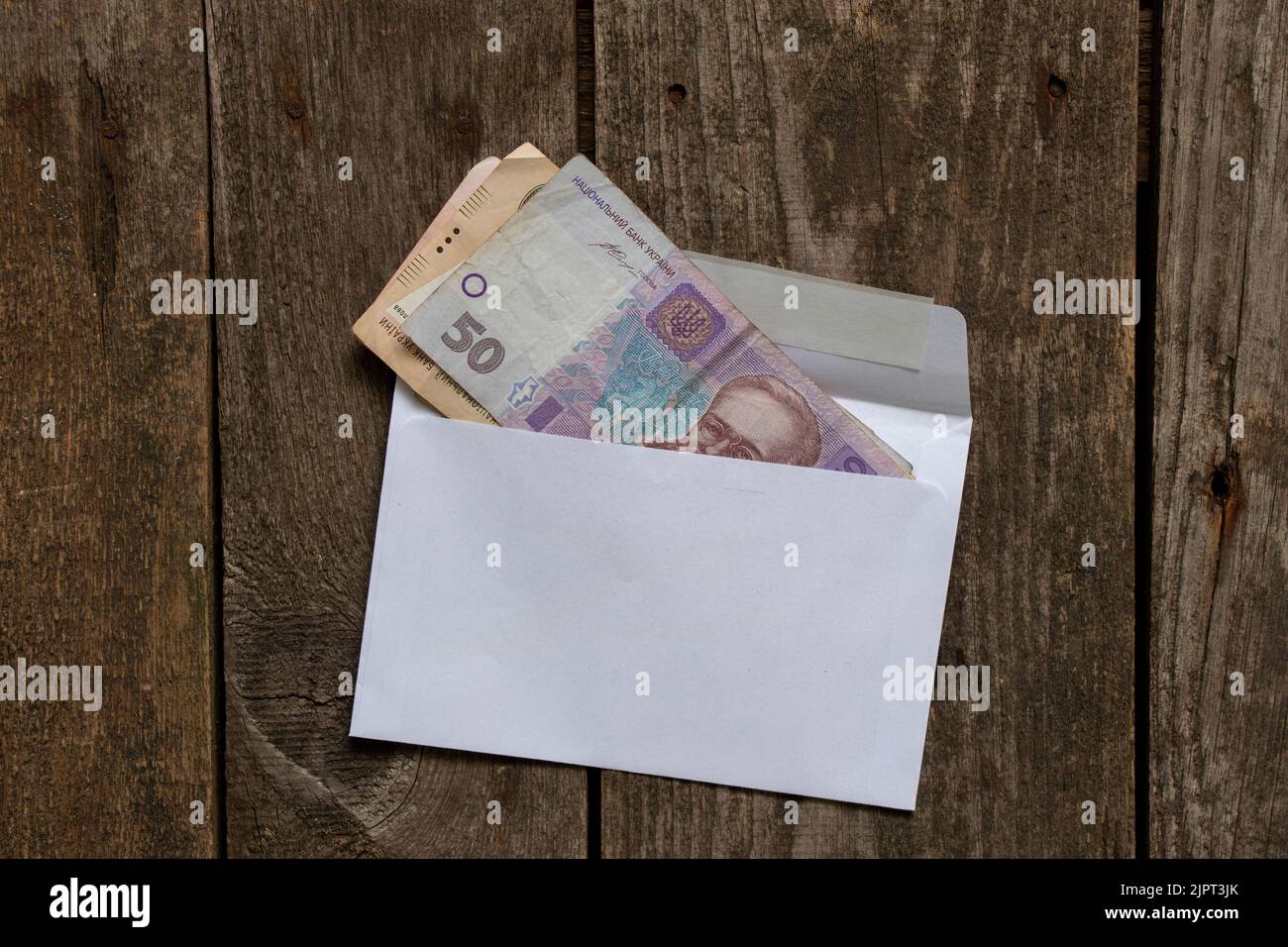 Ukrainian money 50 hryvnia in a white envelope, finance and salary in ...