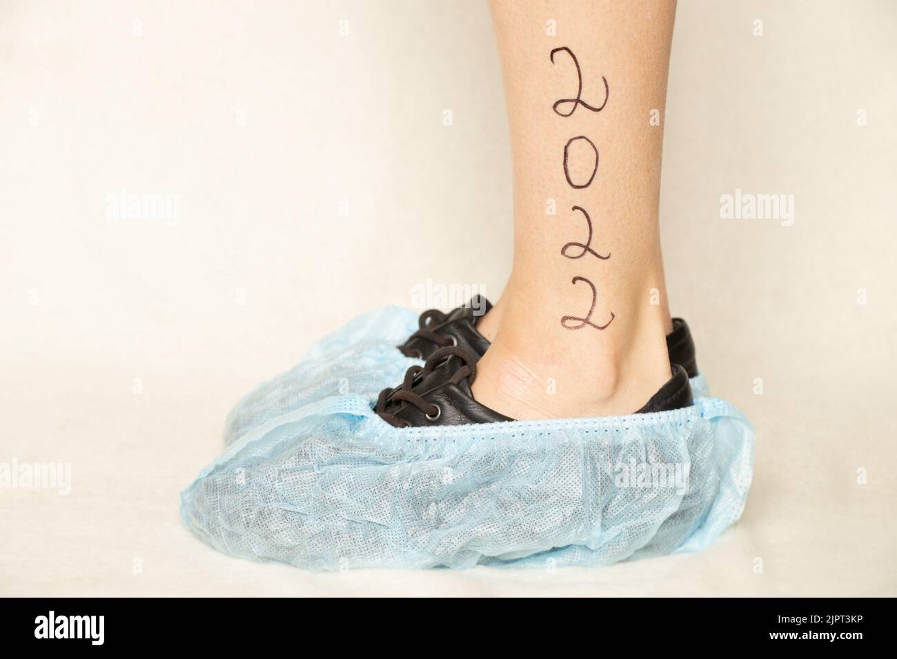 feet in shoes and shoe covers and on the leg text 2022, health in the ...