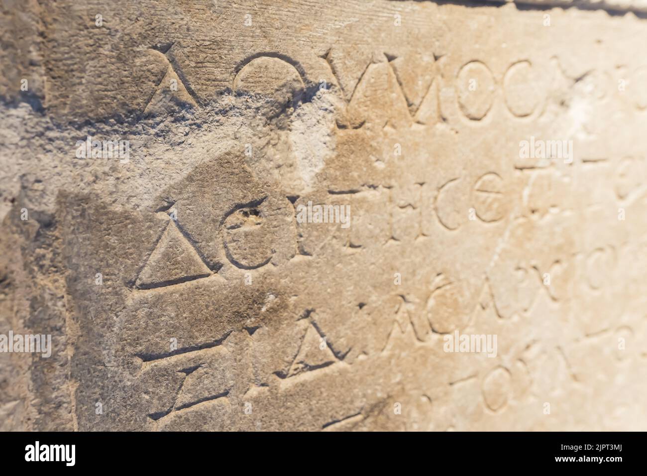 Old Ancient Greek alphabet sentence on a stone wall. Closeup shot. Travel ideas. . High quality ...