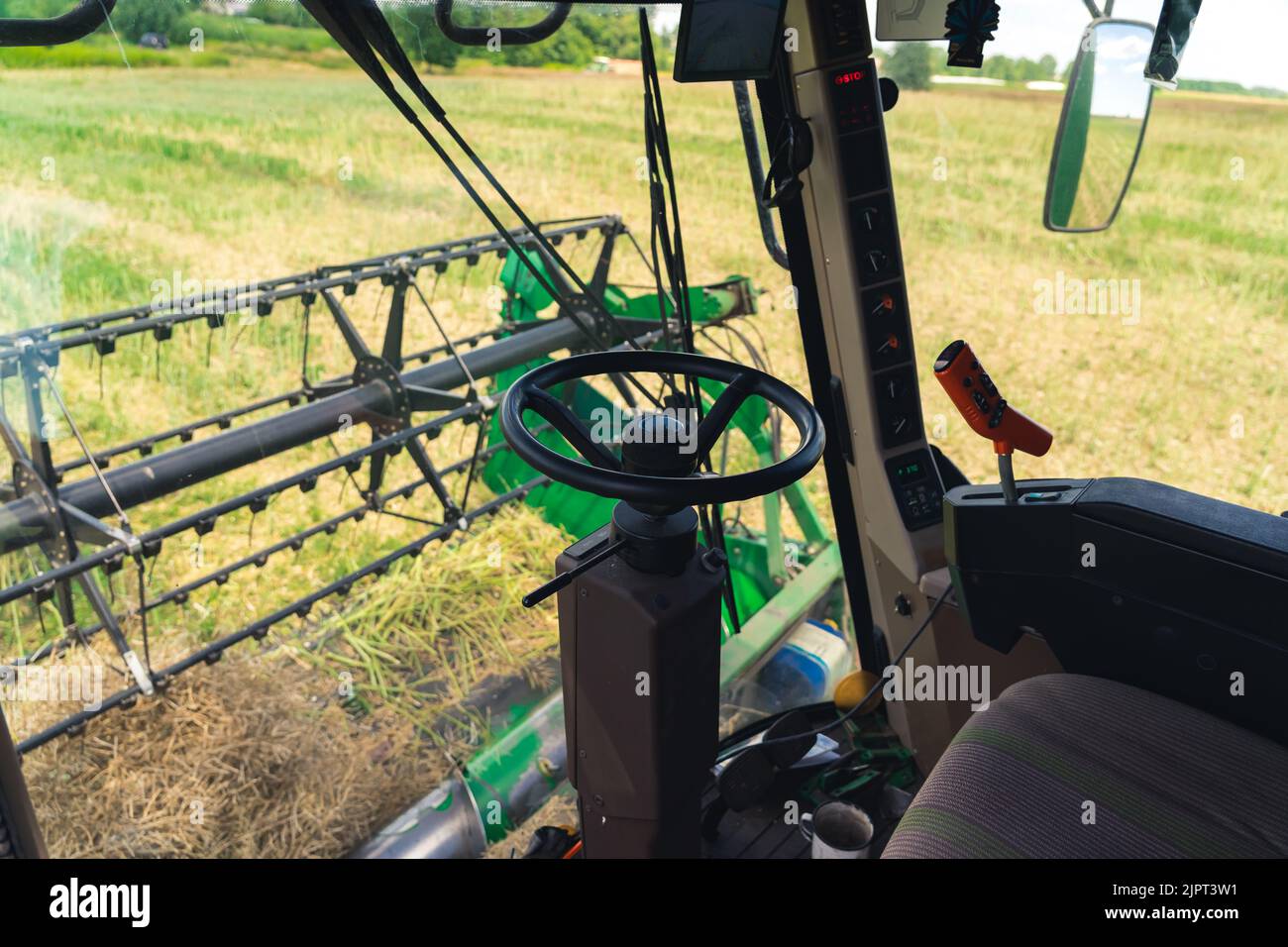 The inside of a modern combine harvester. Steering wheel, seat, side ...
