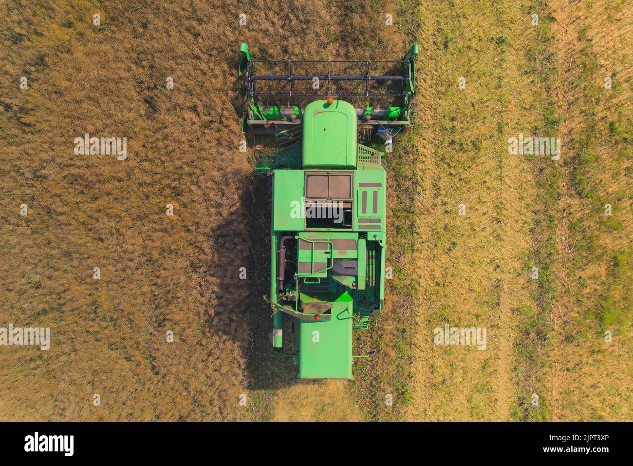Top central view of an agricultural machine - green combine - working ...