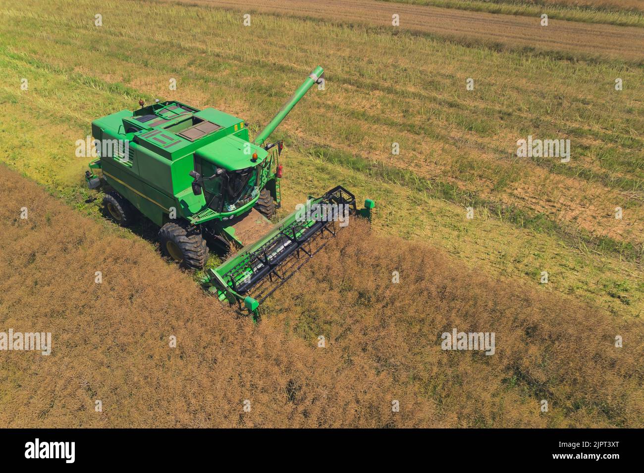 Aerial view of a farmer's machine - green combine harvester - during ...