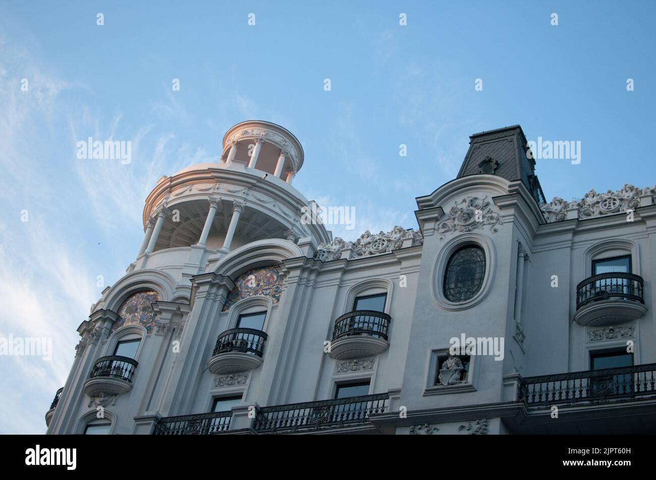 A low-angle shot of Edificio Grassy building on Gran via street. Madrid ...