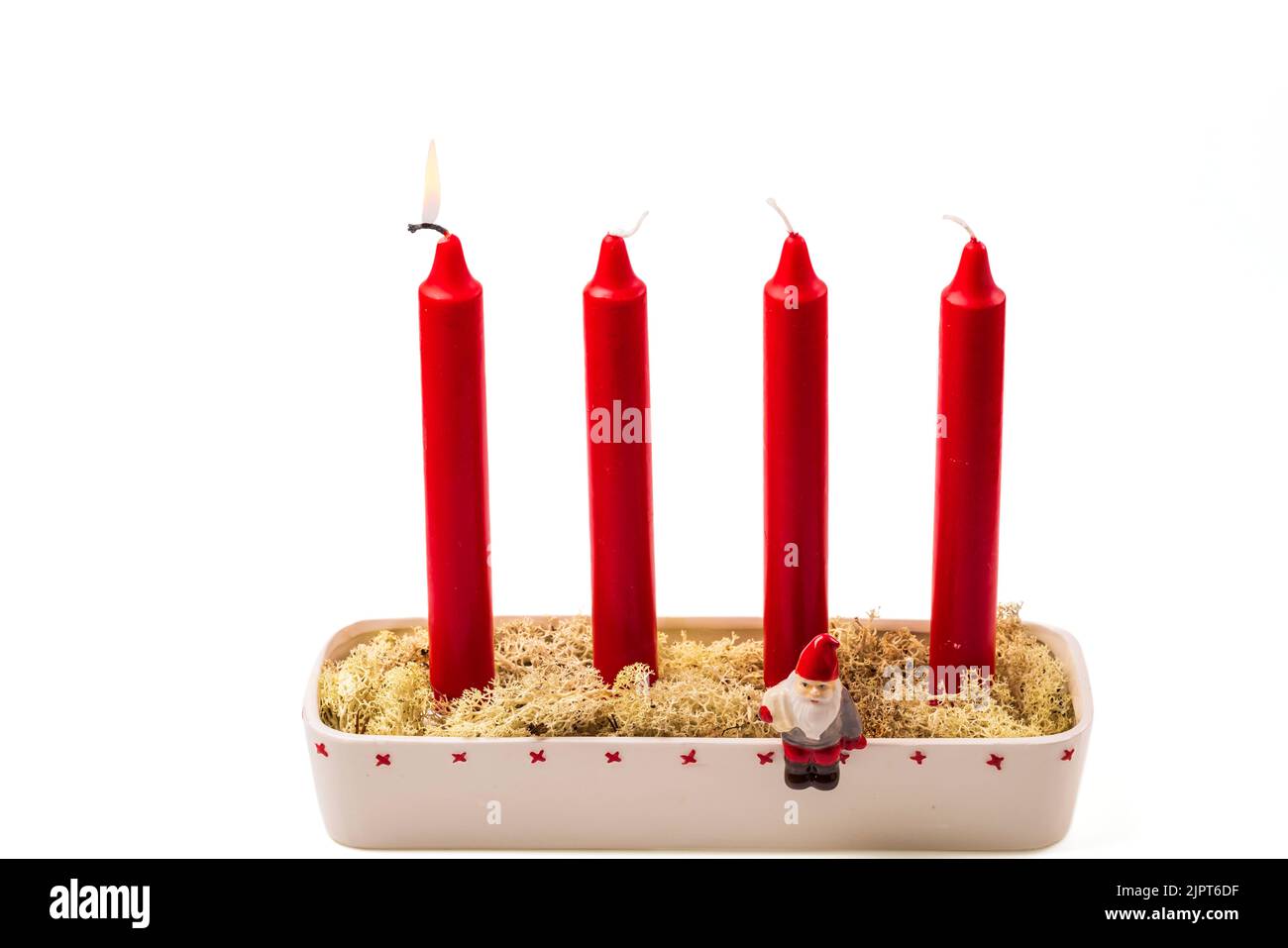 Close up view of traditional candlestick filled with moss with burning ...