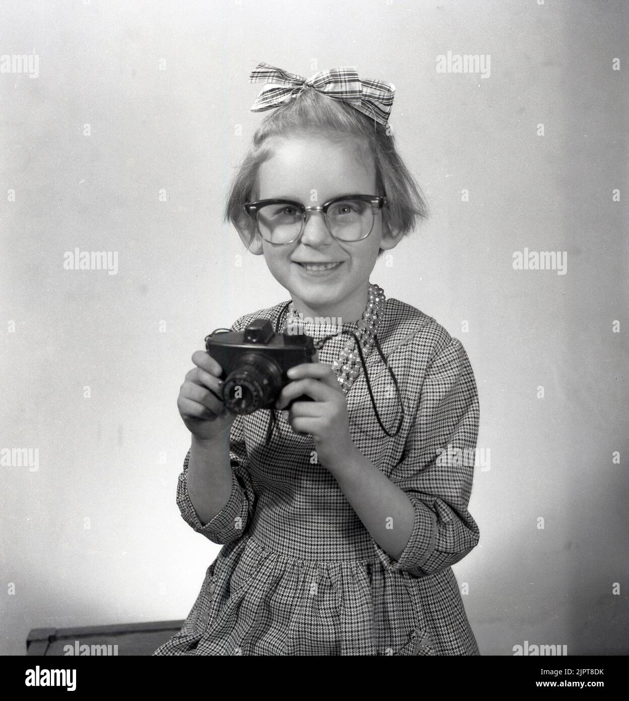 1963, historical, in a photographic studio, a young girl, posing for ...