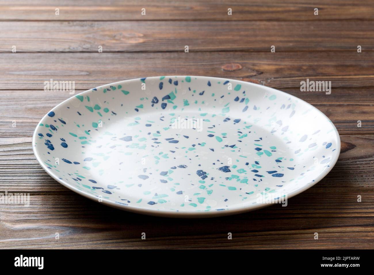 Perspective view of empty colorful plate on cement background. Empty ...