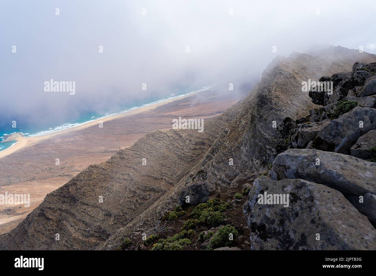 The Pico de la Zarza overlooking foggu Playa de Cofete Beach in ...