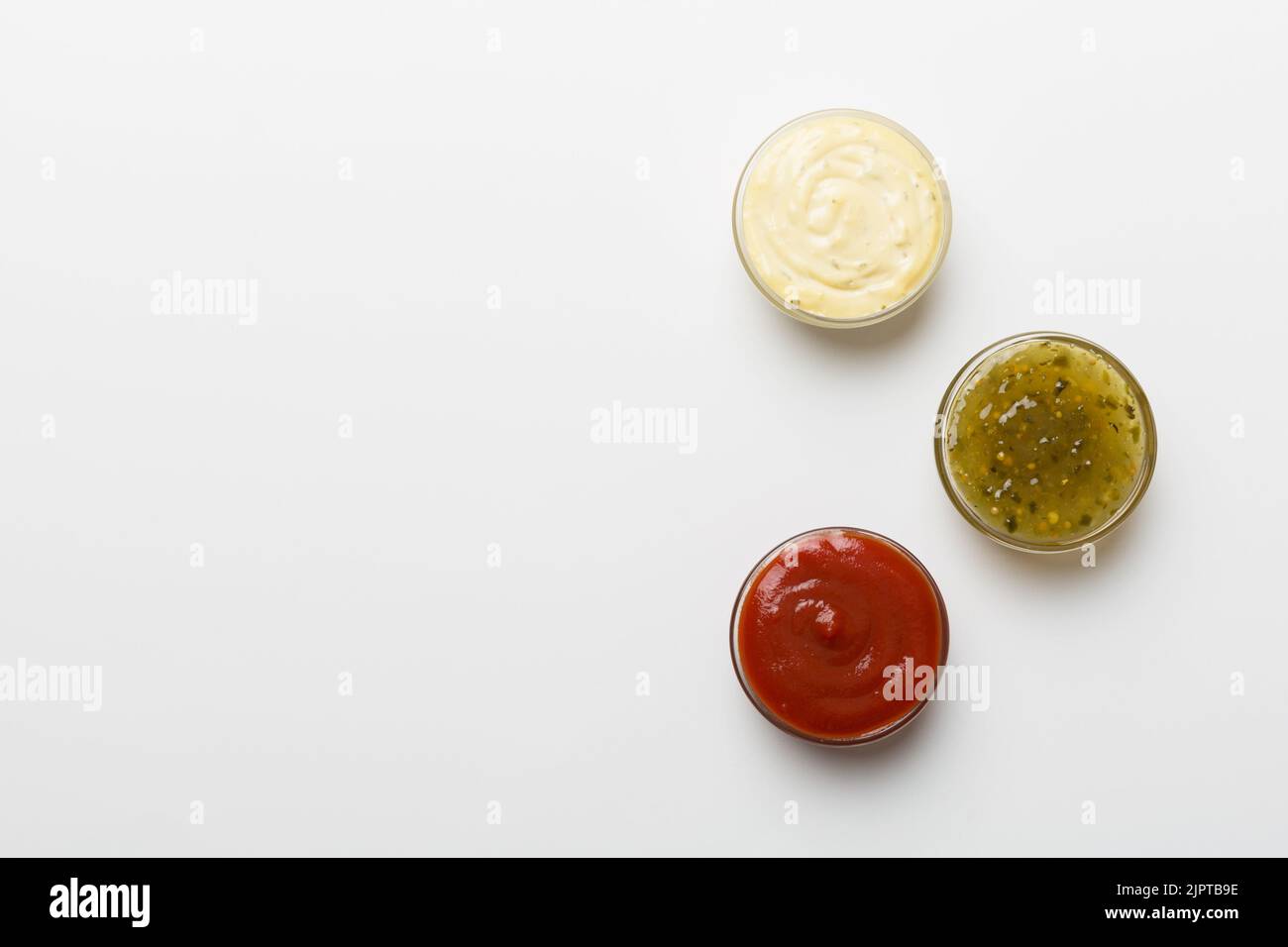 Different types of sauces in bowls on a colored Board . Top view ...