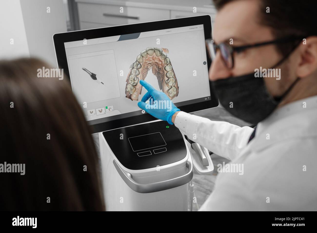 Male doctor show results of digital intraoral scan of patient teeth in ...