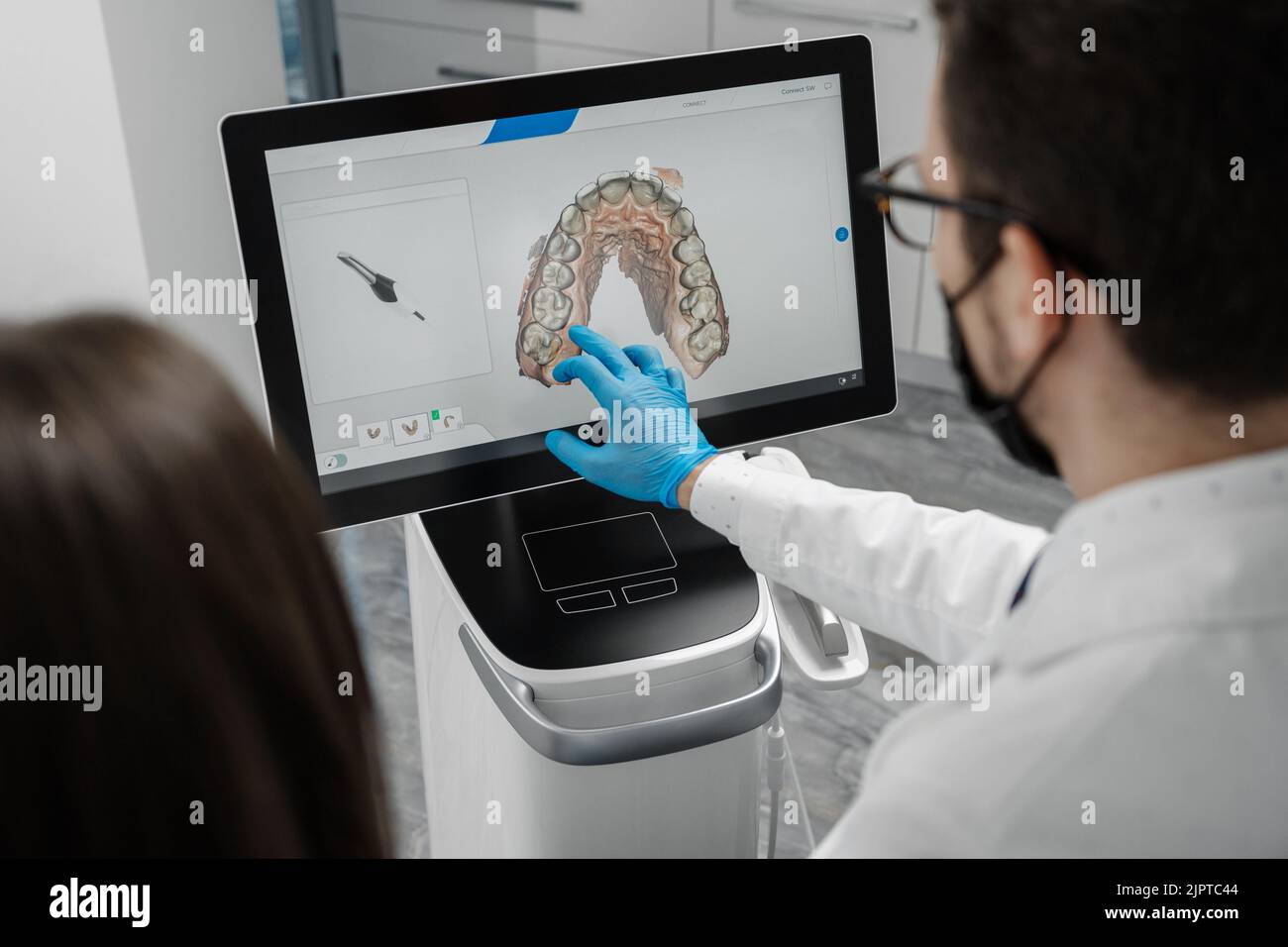 Male doctor show results of digital intraoral scan of patient teeth in ... Male doctor show results of digital intraoral scan of patient teeth in ...
