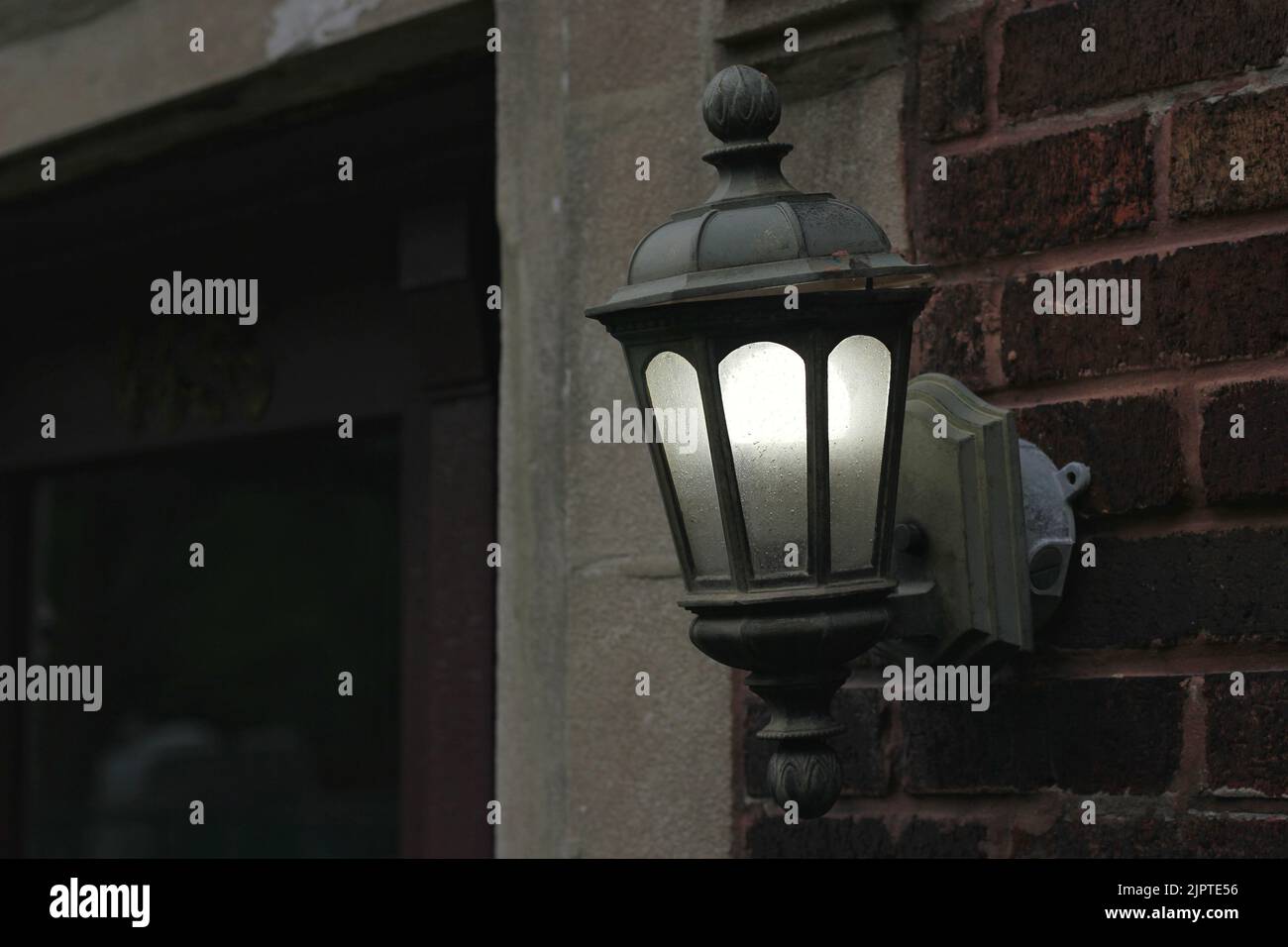 Fancy lantern lamp hanging on the brick wall Stock Photo - Alamy