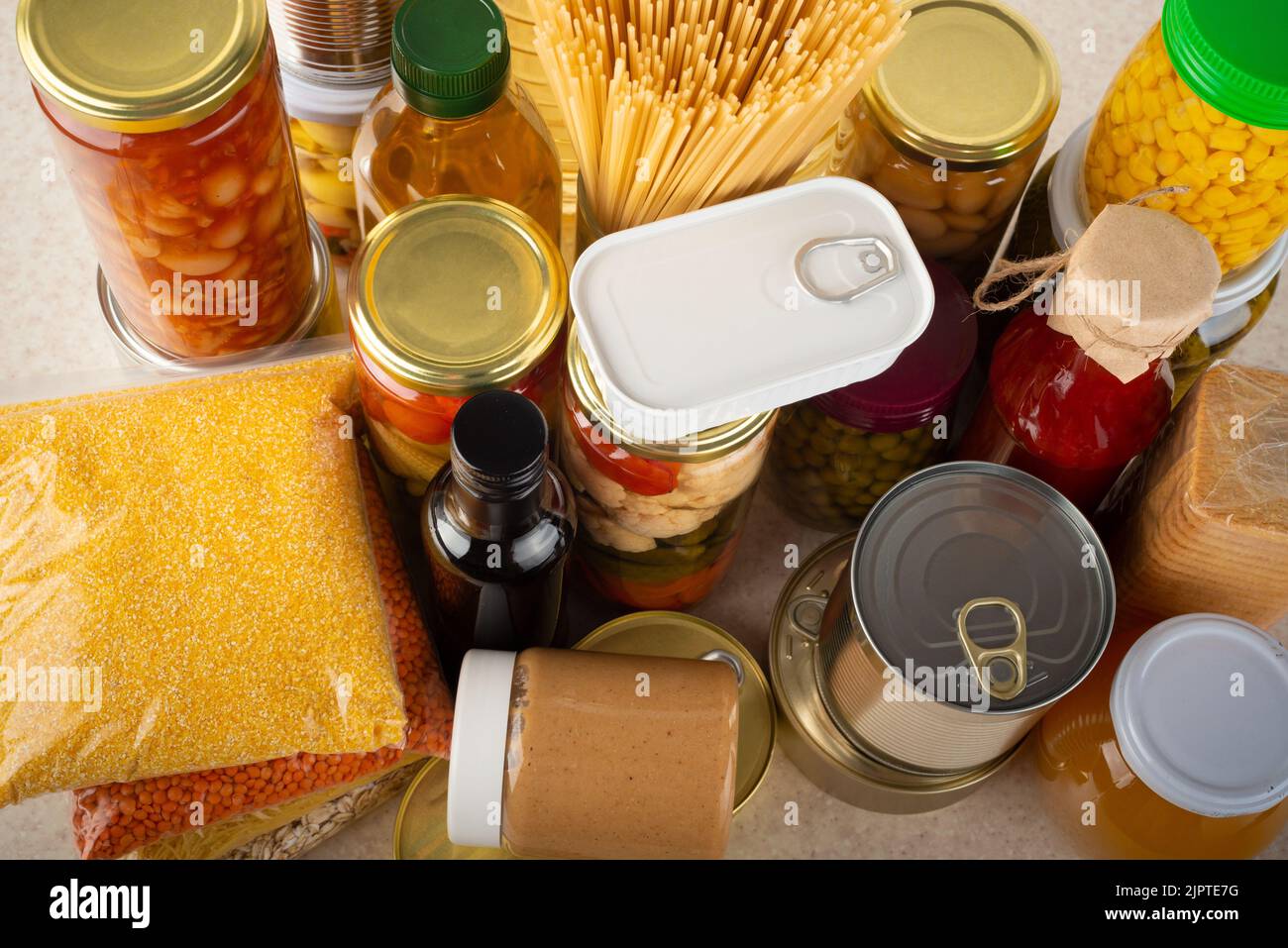 Emergency survival food set on white kitchen table high angle view ...