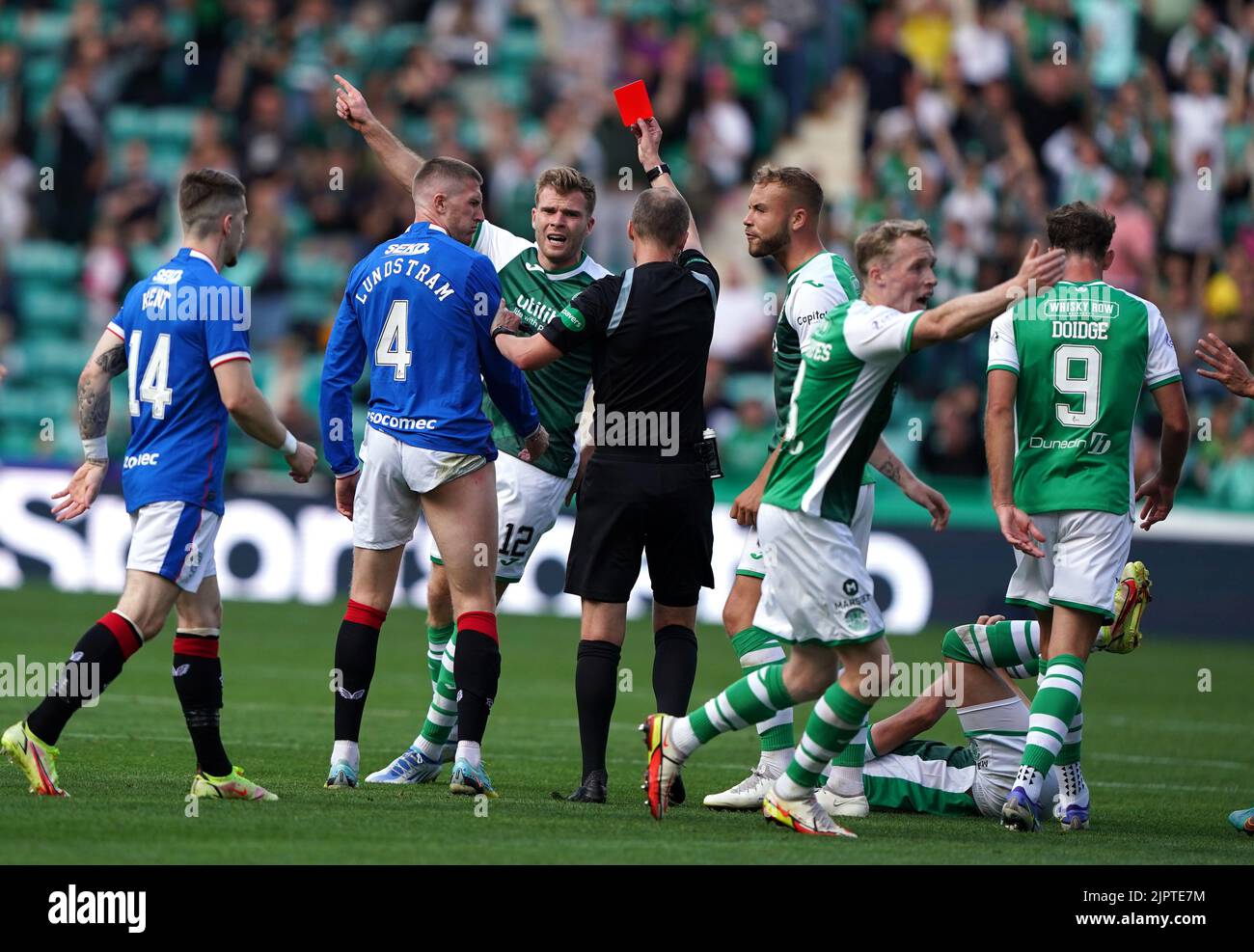 Referee William Collum shows Rangers' John Lundstram a red card during ...