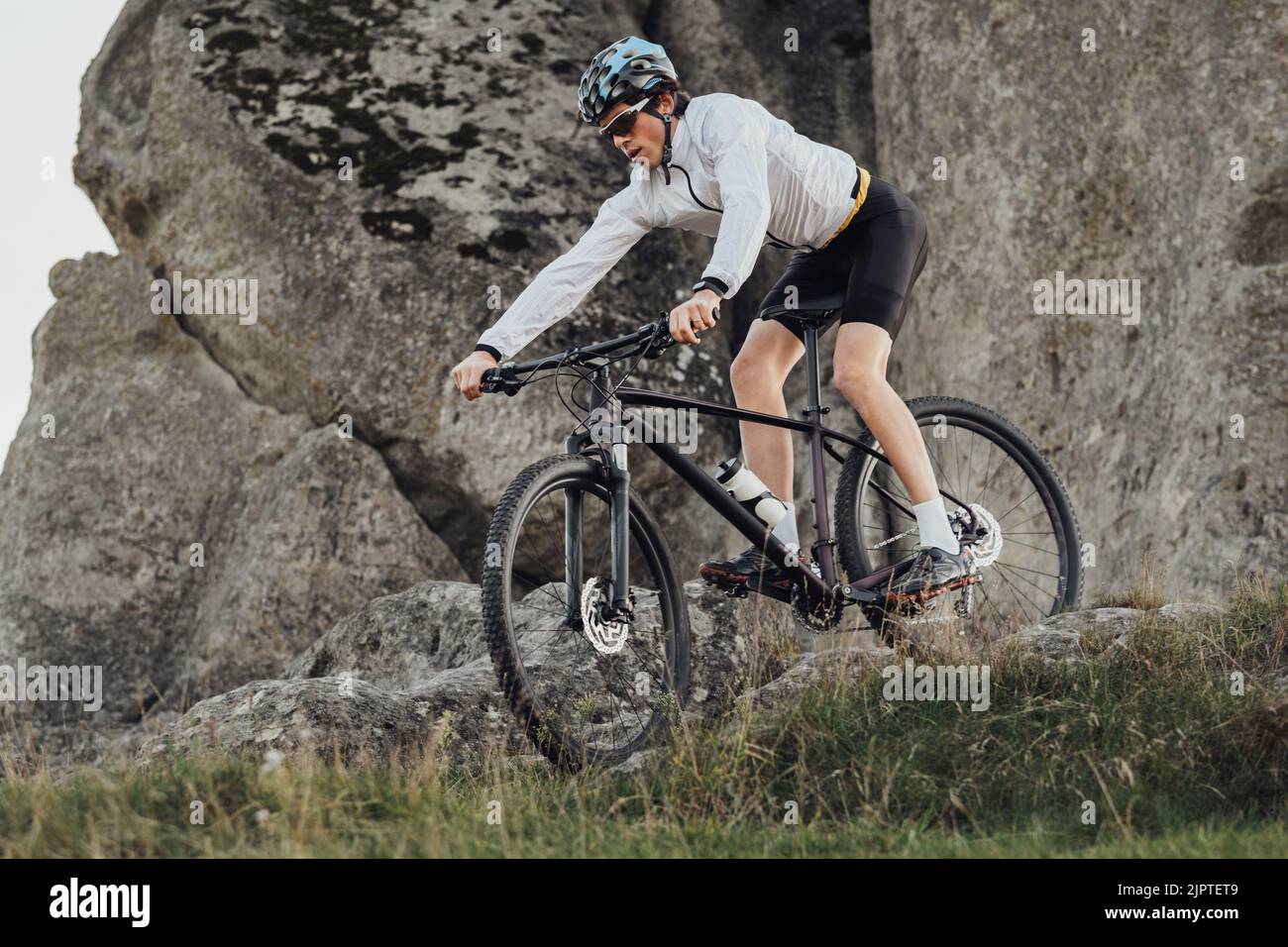 Equipped Professional Cyclist Descends a Slope on His Mountain Bike ...
