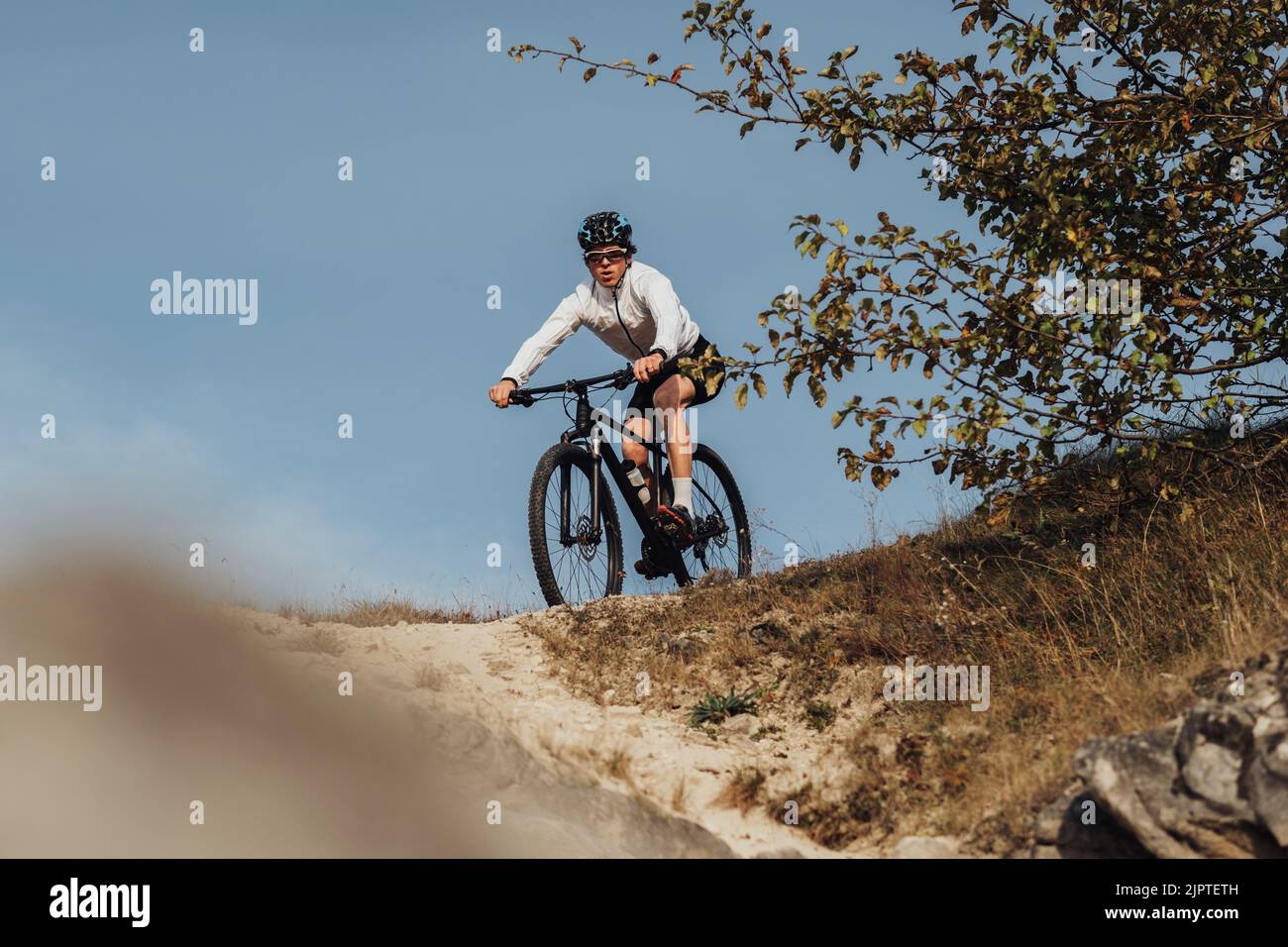 Equipped Professional Cyclist Descends a Slope on His Mountain Bike ...