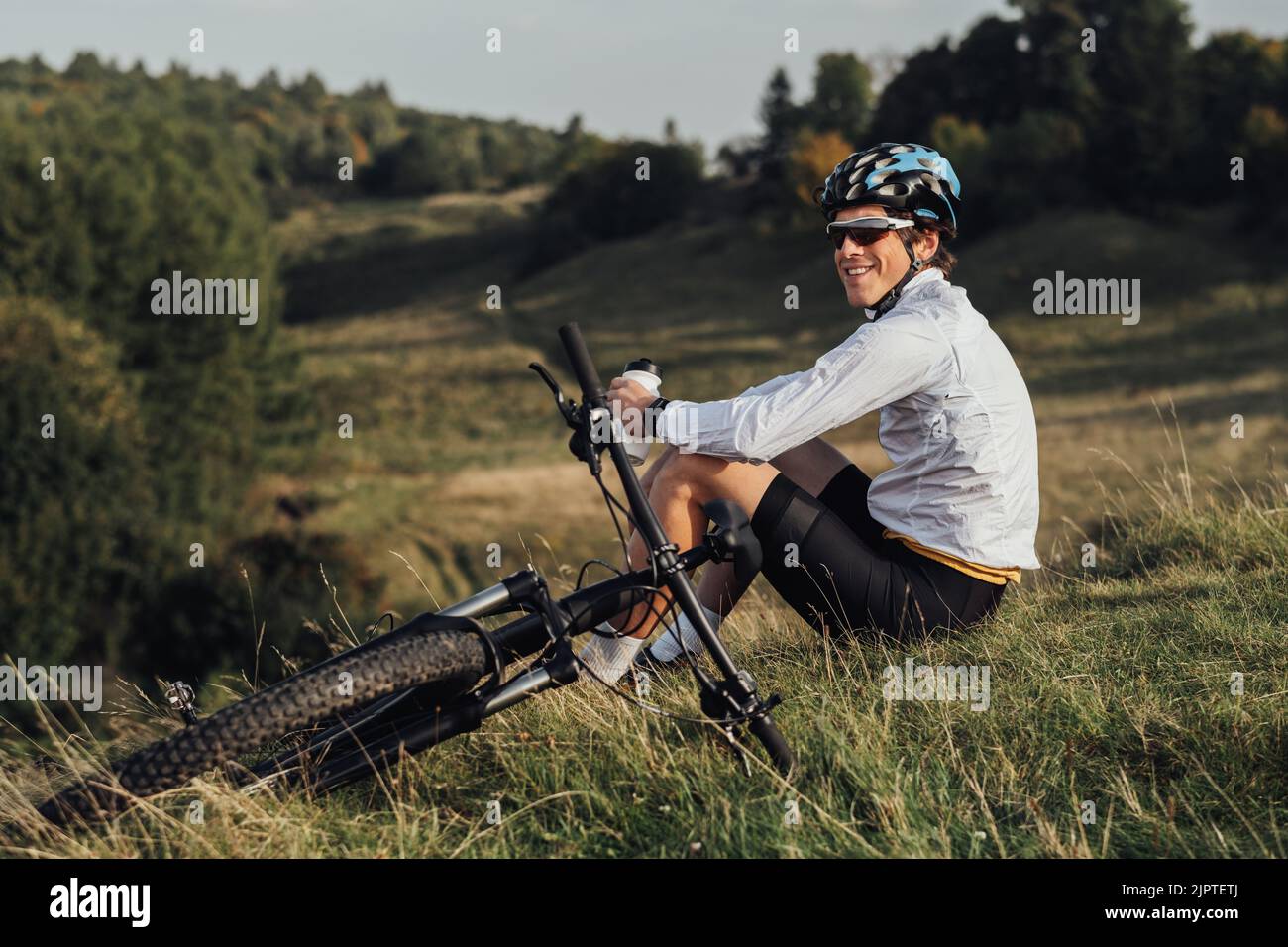 Professional Male Cyclist Drinking Water from Bottle, Man Sitting Near ...